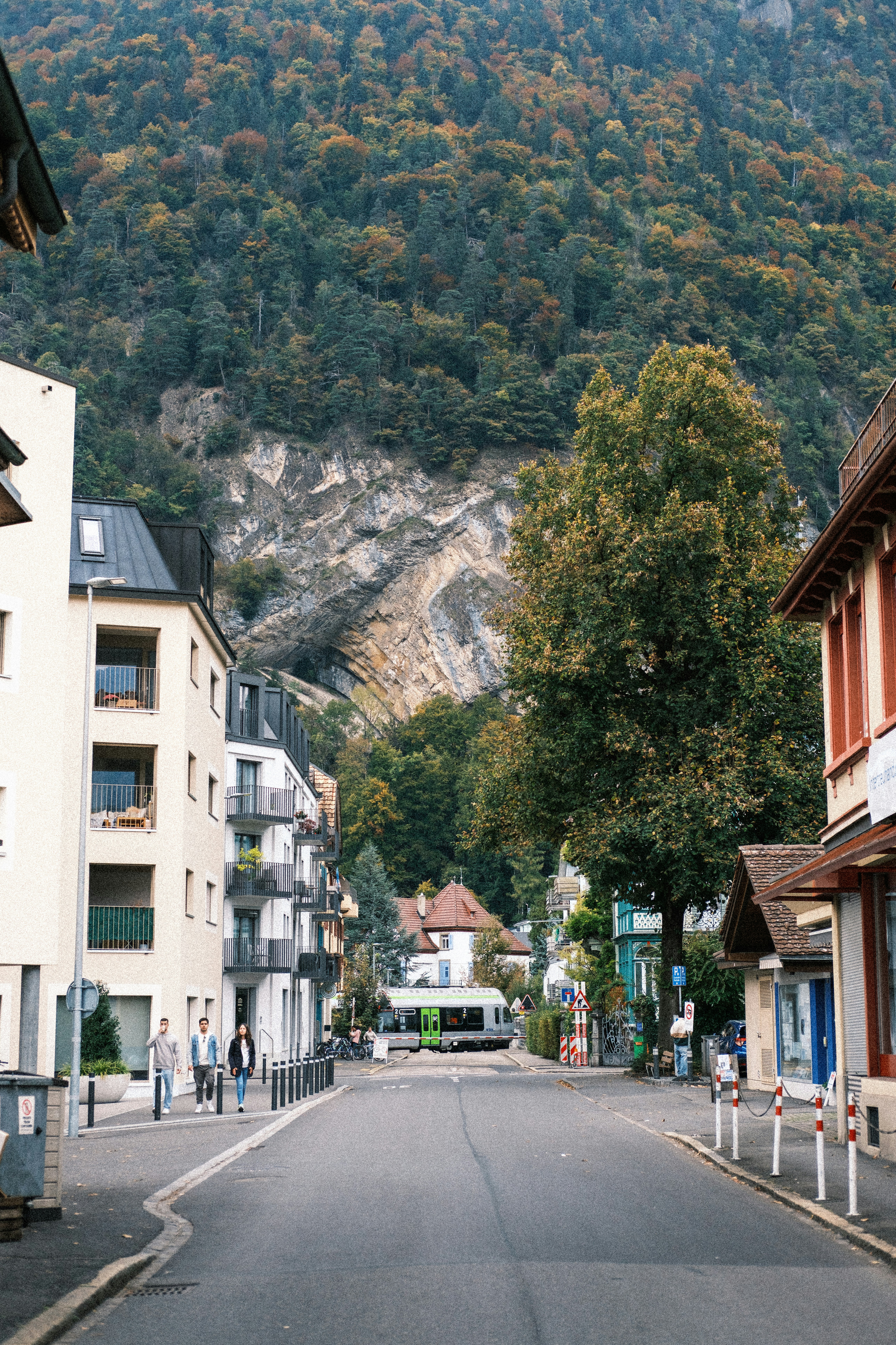 Mountain Town Street Descends Toward a Quiet Bus Stop