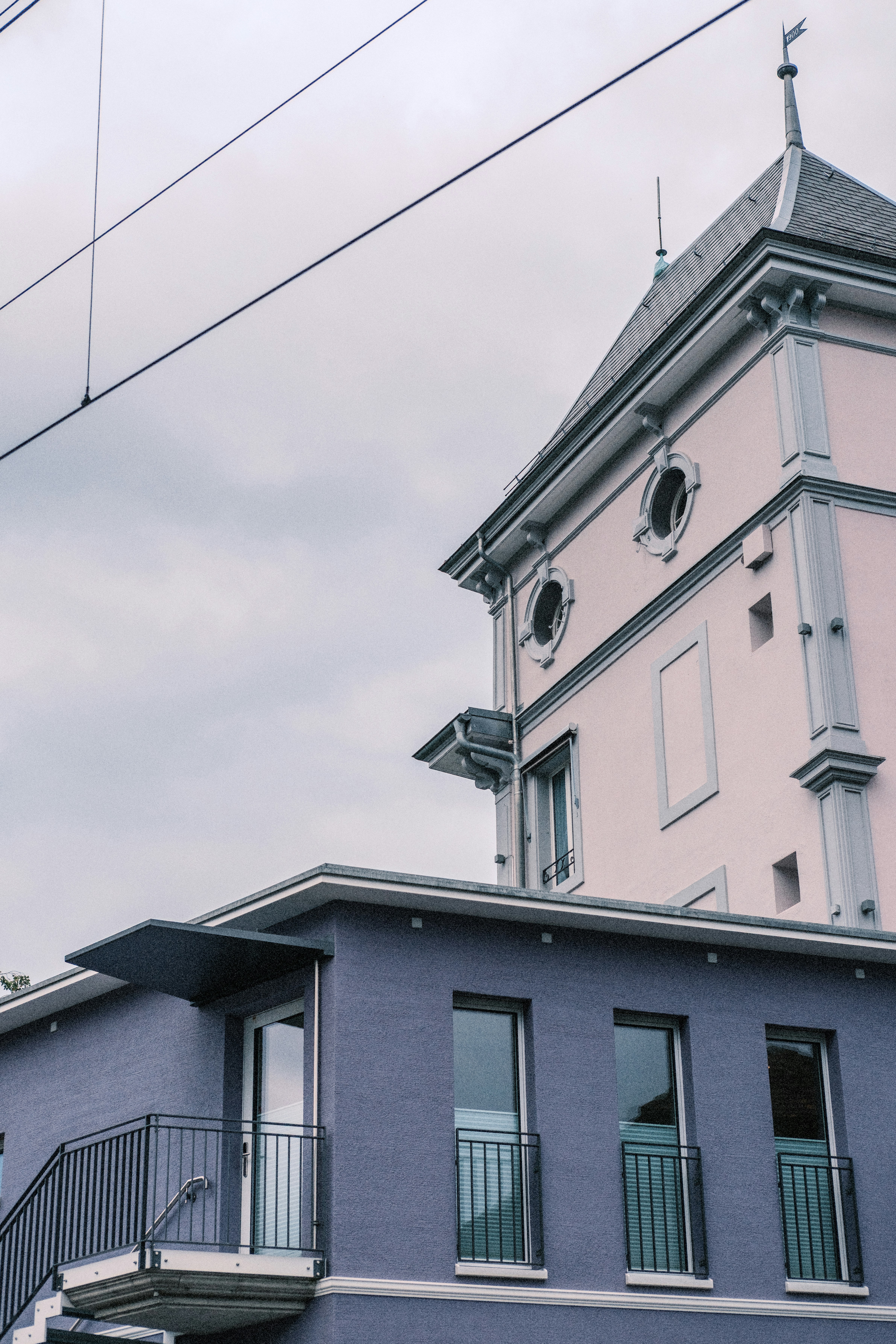 Edge of Architecture: A Cornered Facade under Overhead Cables