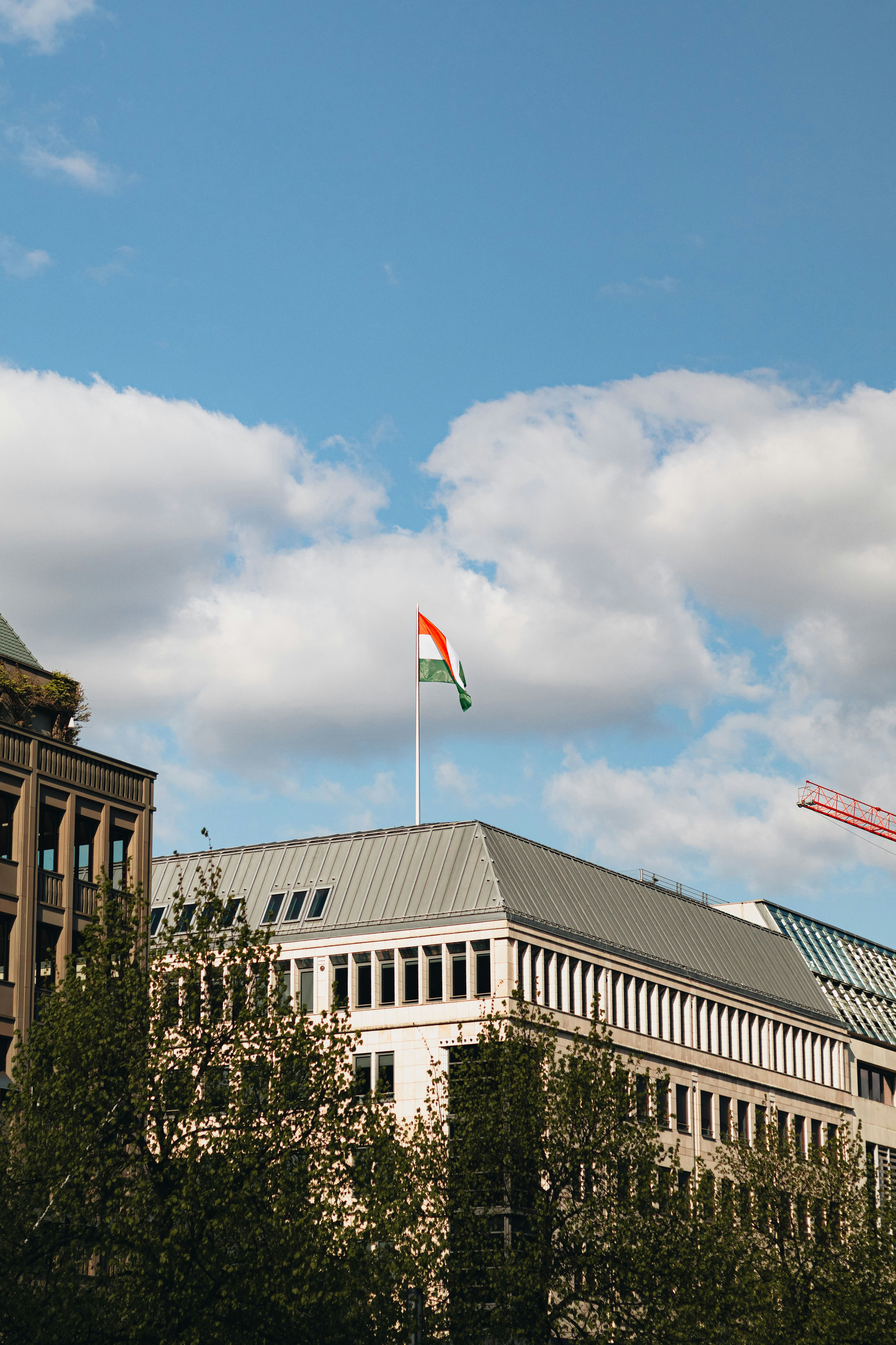 Flag atop the corporate roof under a bright sky