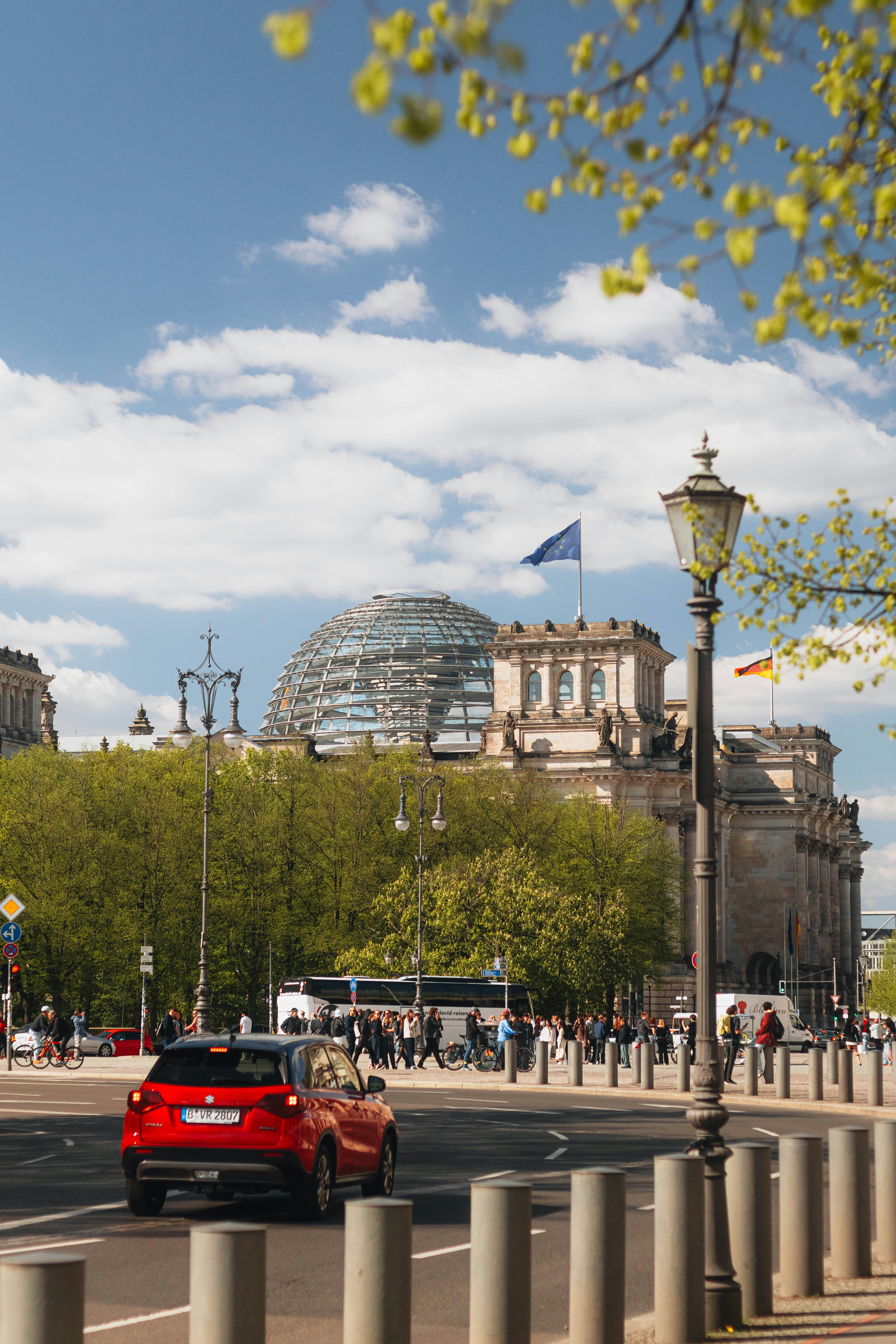 Streets of Berlin: Car, Glass Dome, and Historic Facade