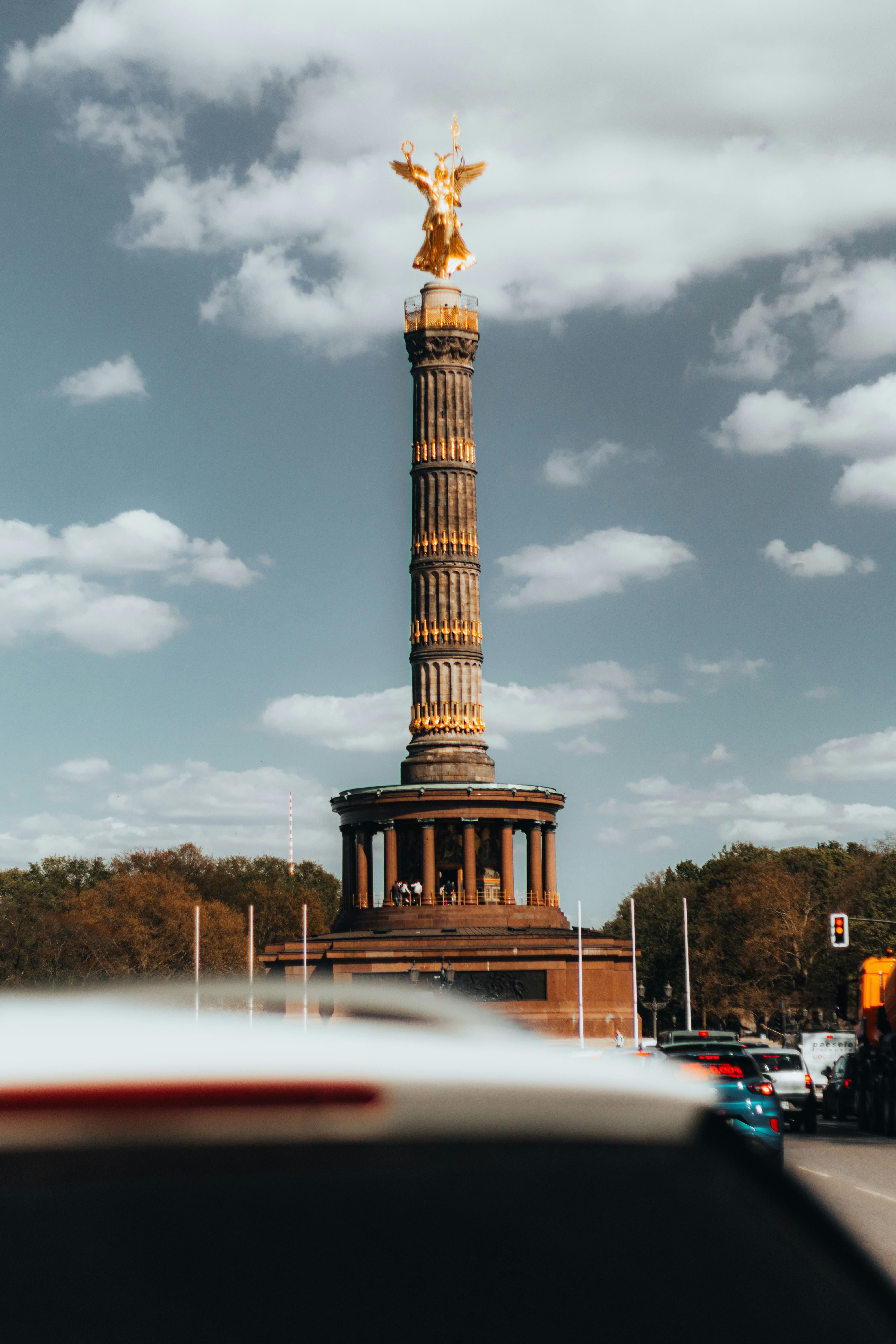 Golden Angel on a Tall Column: Berlin-like Victory Monument Framing Above Traffic
