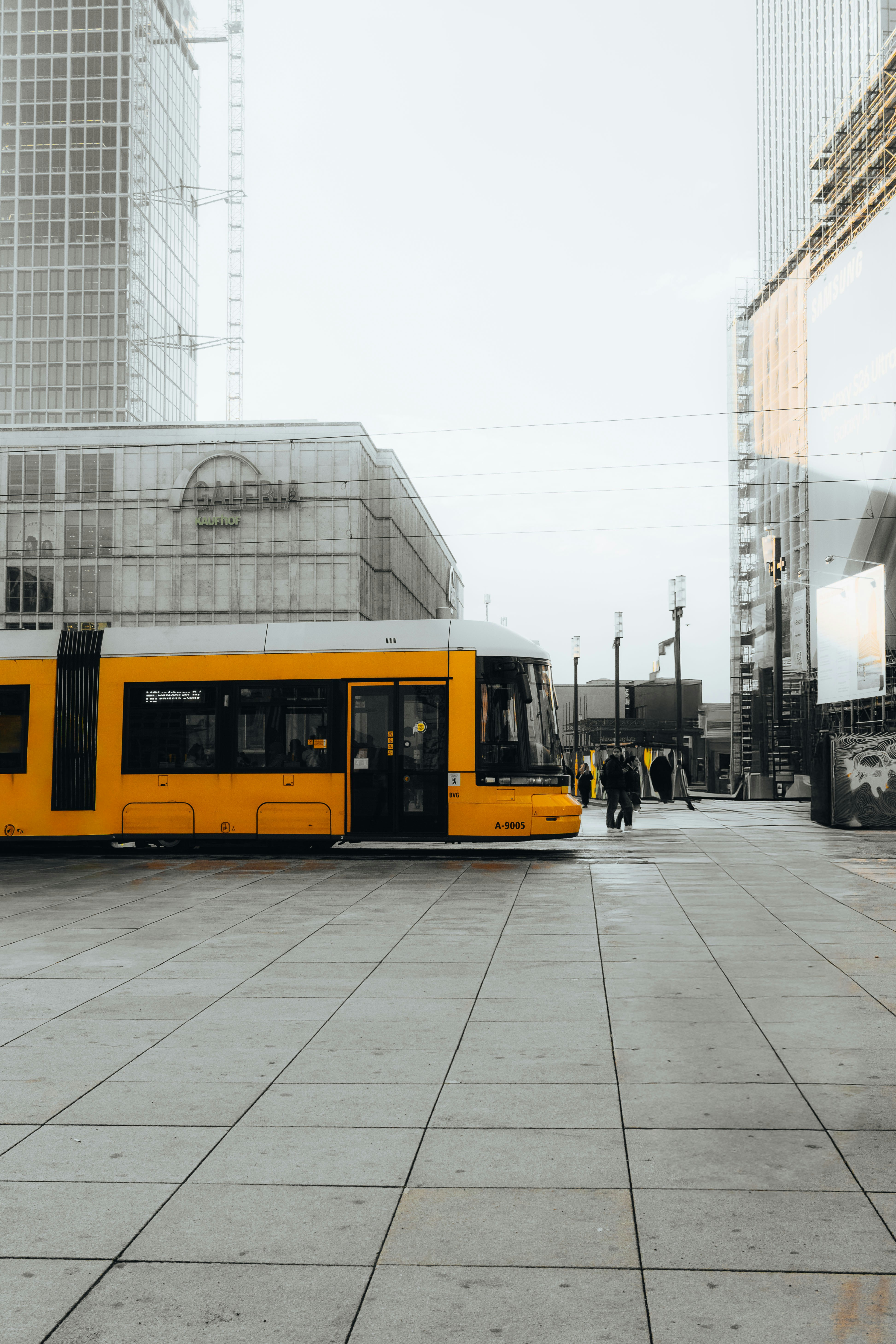 Urban Transit: Neon-Tinted Tram Meets Quiet Square