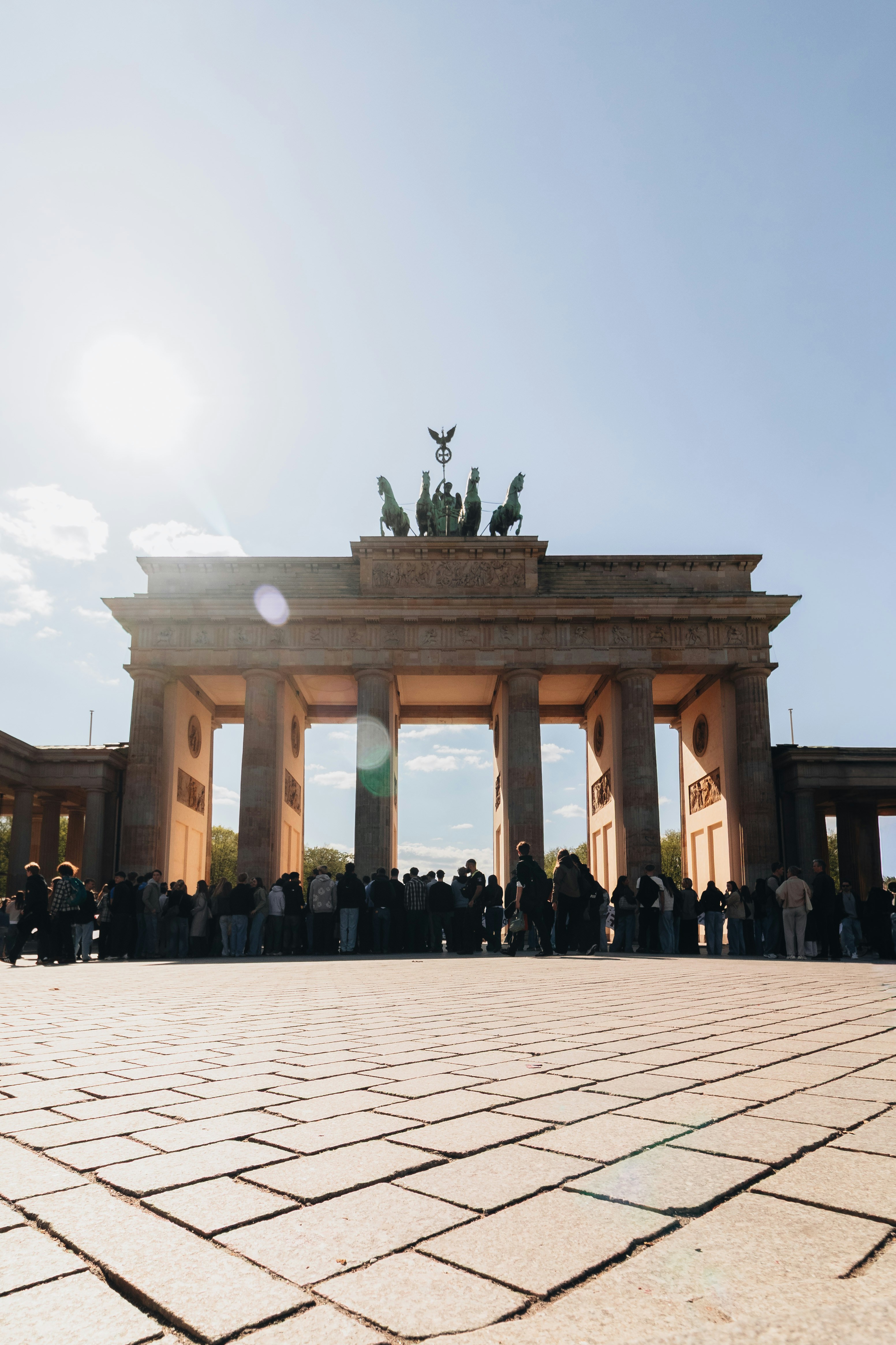 Sunlit Arc of History: A Crowd Beneath the Brandenburg Gate