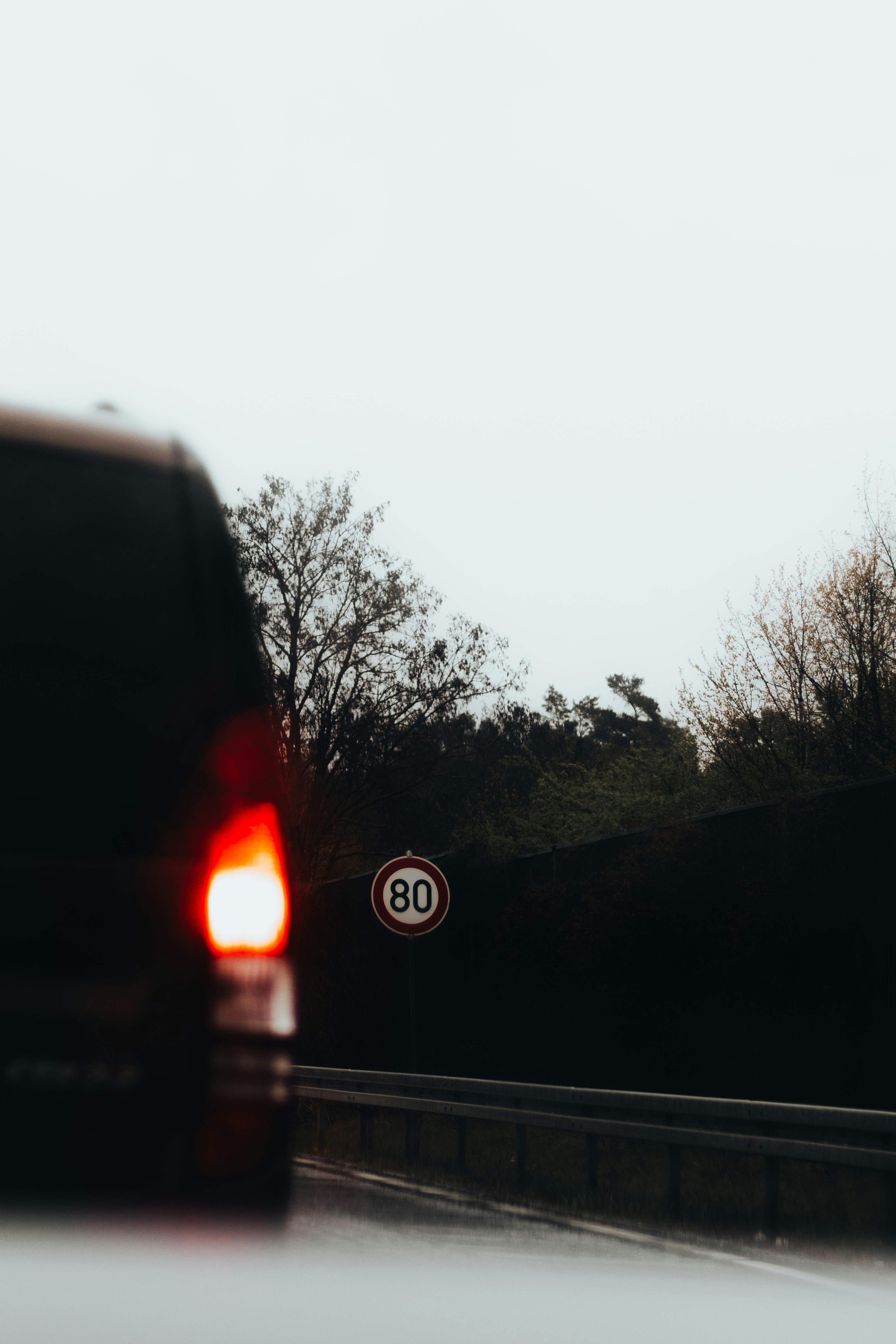 Brake lights and speed limit: a roadside pause on a dim afternoon