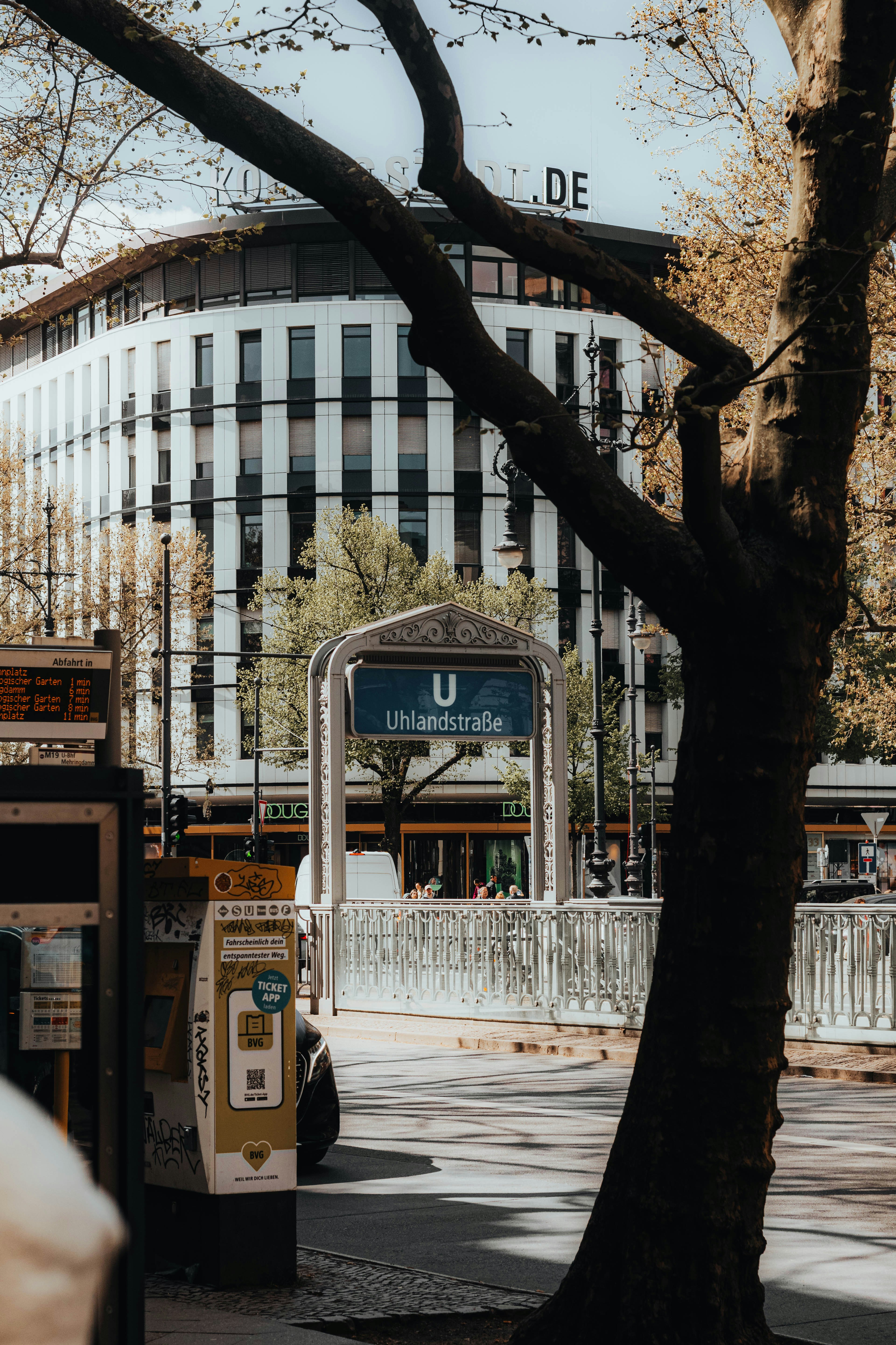 Urban Entrance: U-Bahn Sign Framed by Tree Branches and Modern Architecture