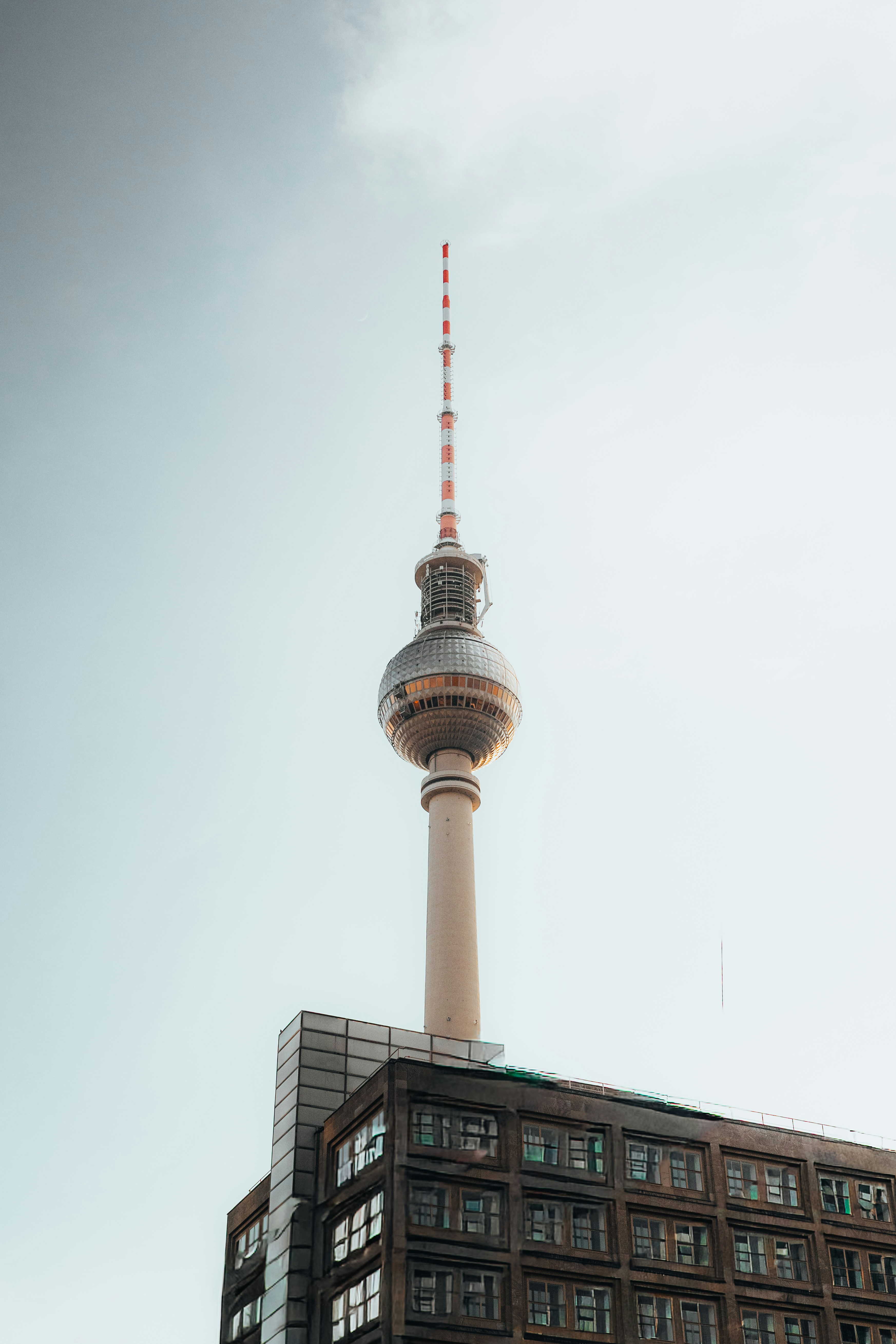 Tall television tower above a building