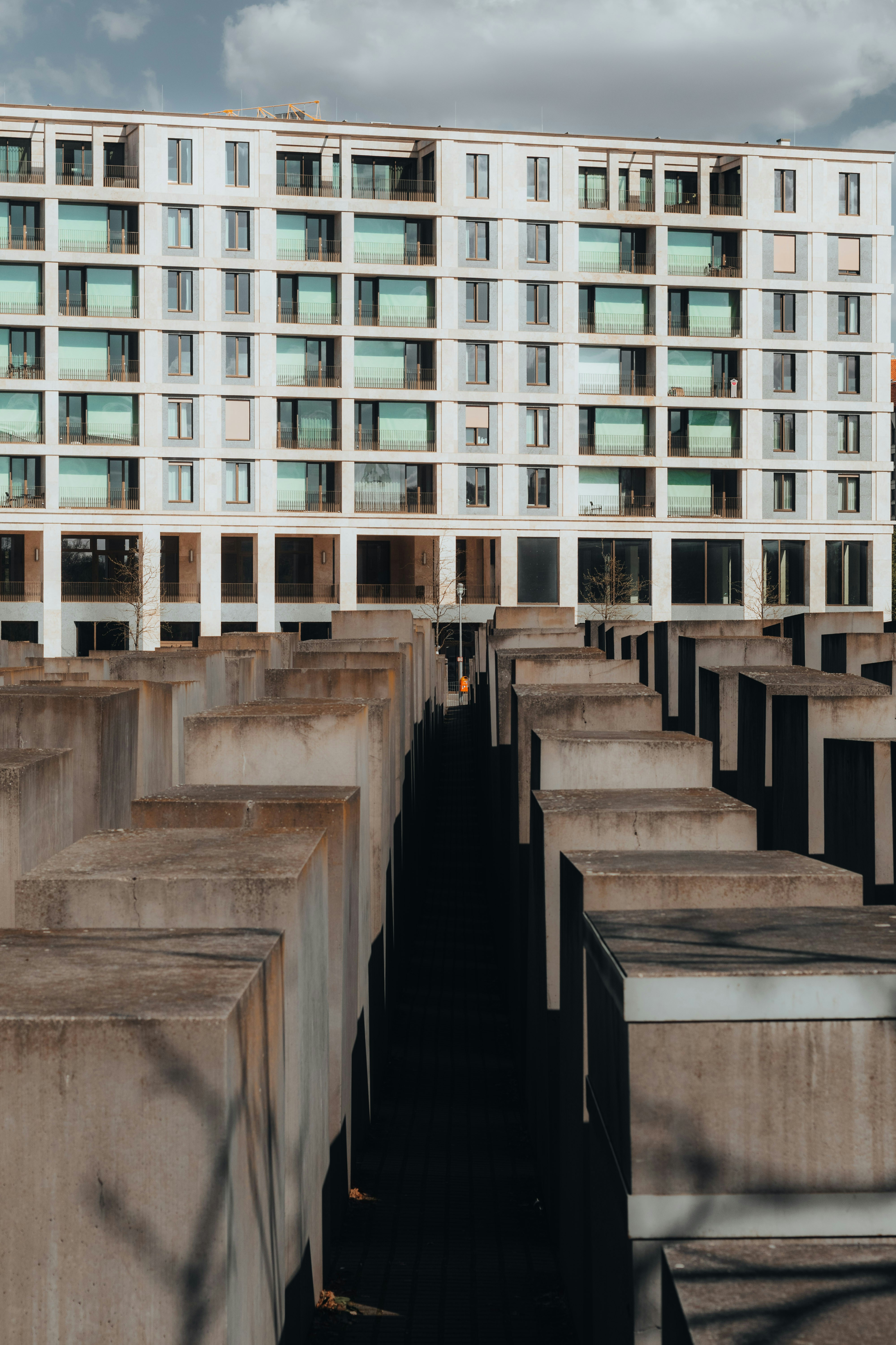 Concrete Memorial: Rows of Pillars Leading to a Modern Glass-Faced Block