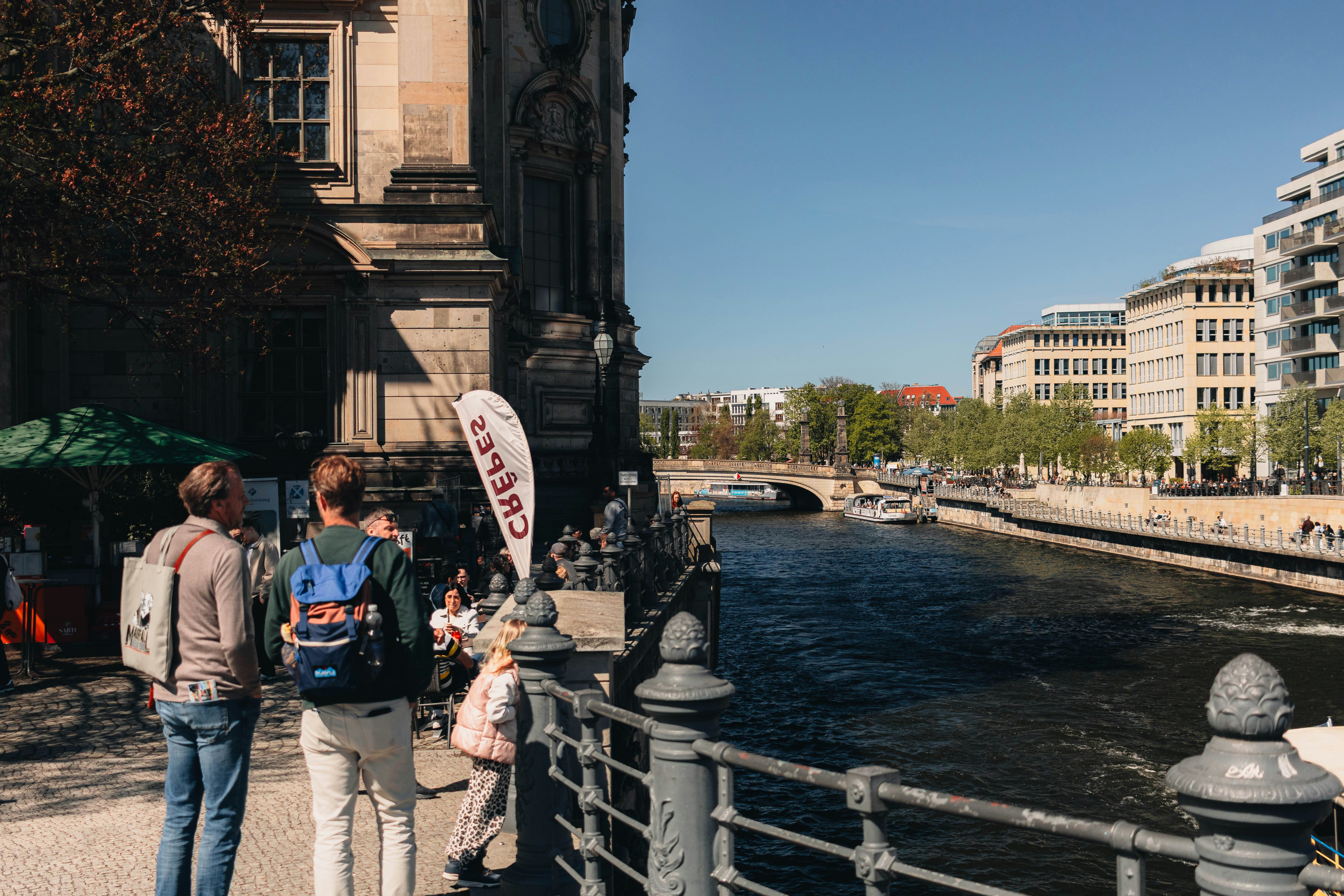 Riverbank Portraits: Cityscape and Pedestrian View by the Spanning Canal
