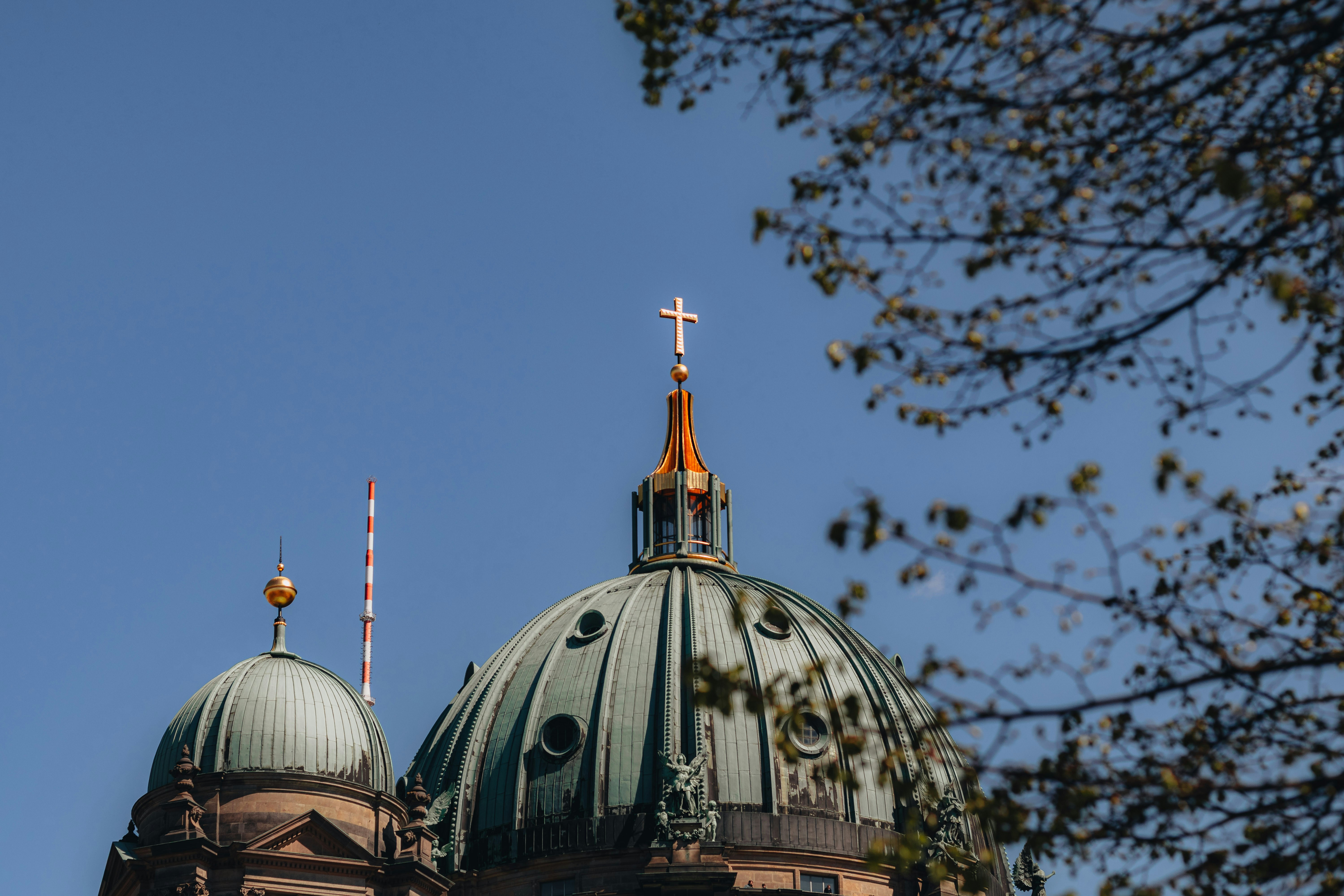 Cross at the Apex: A Cathedral Dome Against a Clear Sky
