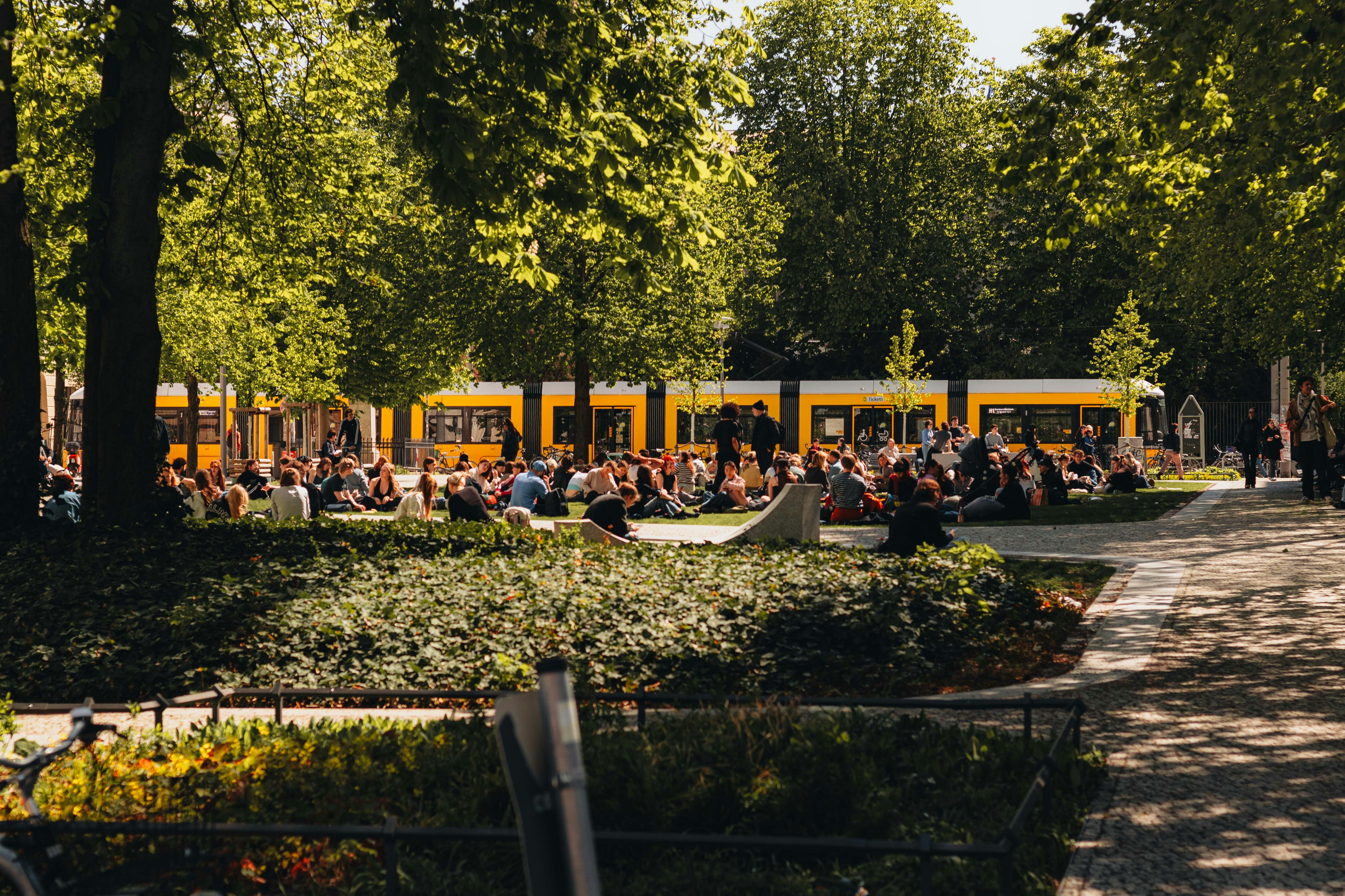 Sunlit Terrace Pulse: A Drone of Laughter in a City Park