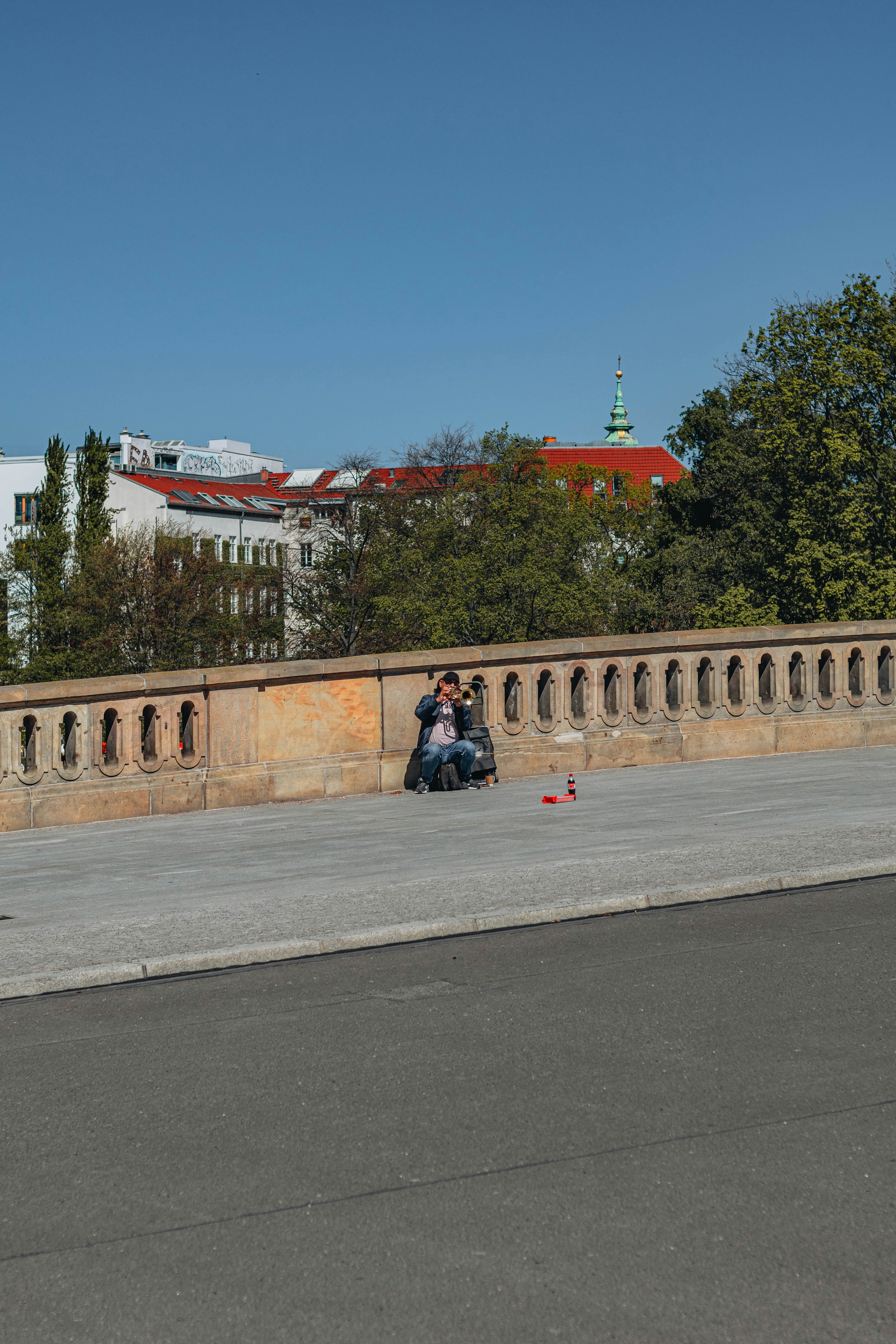 Couple Seated on a City Bridge with Basin of Trees and Historic Railings