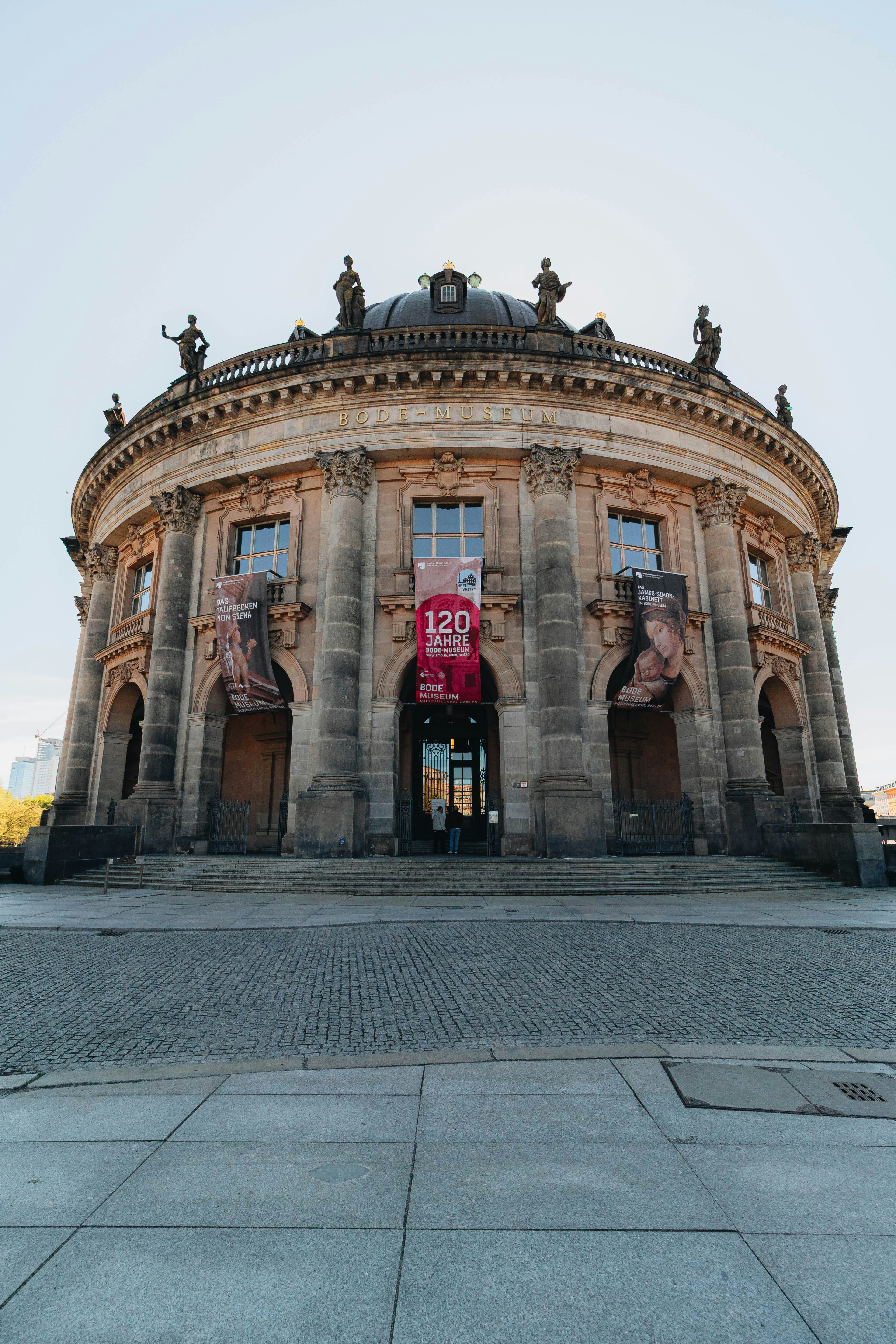 Circular Baroque Facade of a Historic Building Adorned with Banners