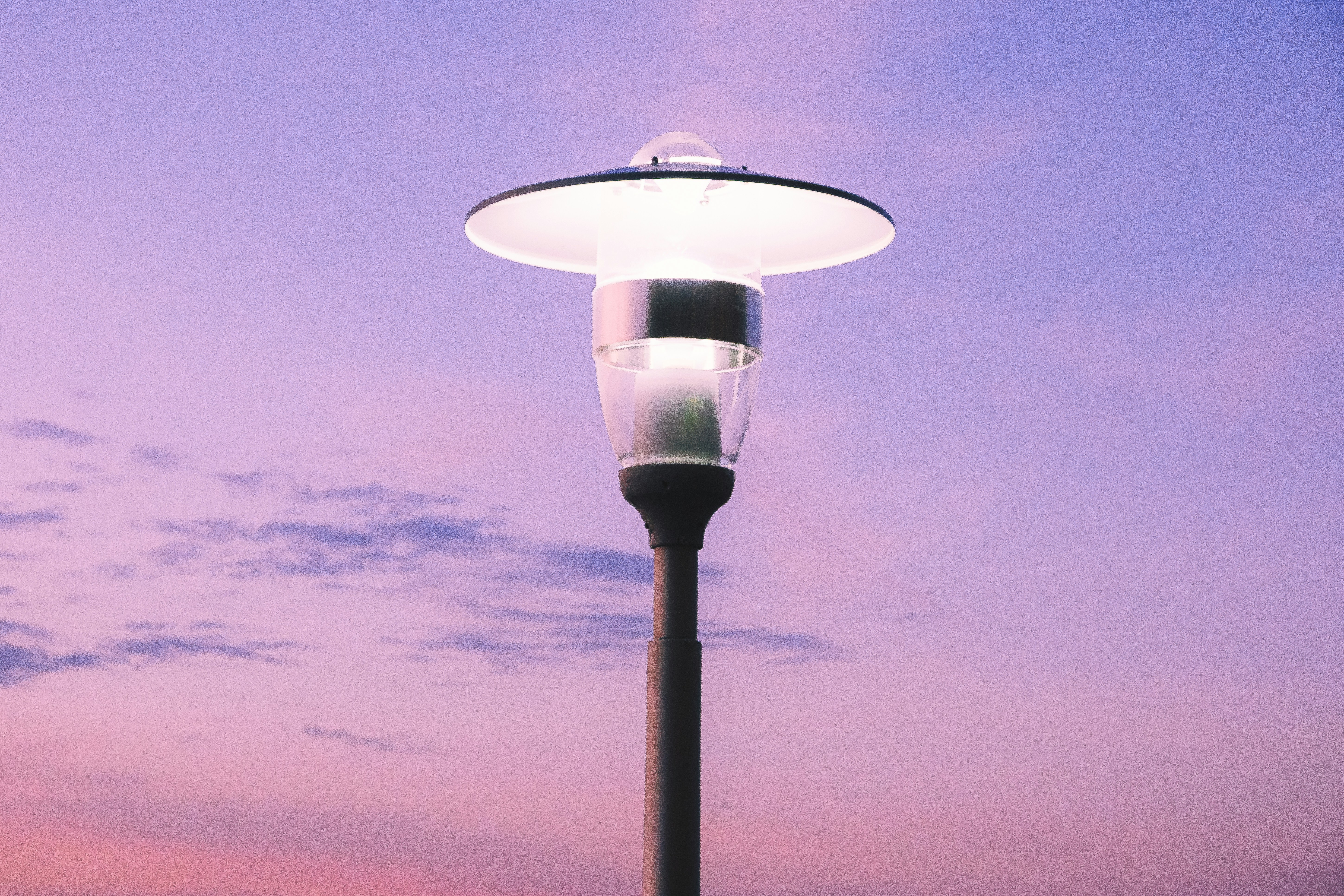 Twin Halo of Evening: A Lone Lamp Pierces the Lavender Sky