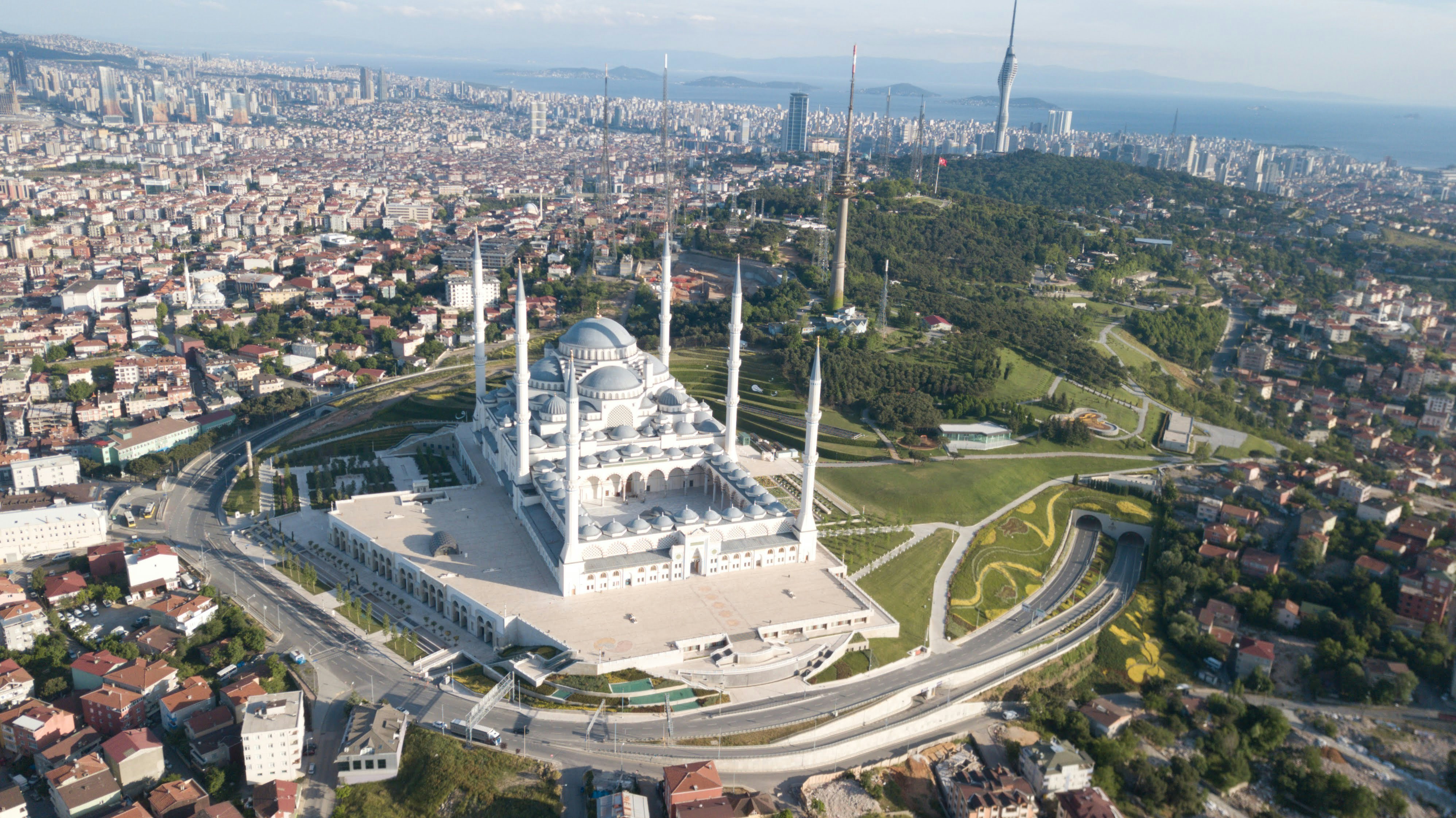White Mosque Crowned by Minarets Over a Verdant City