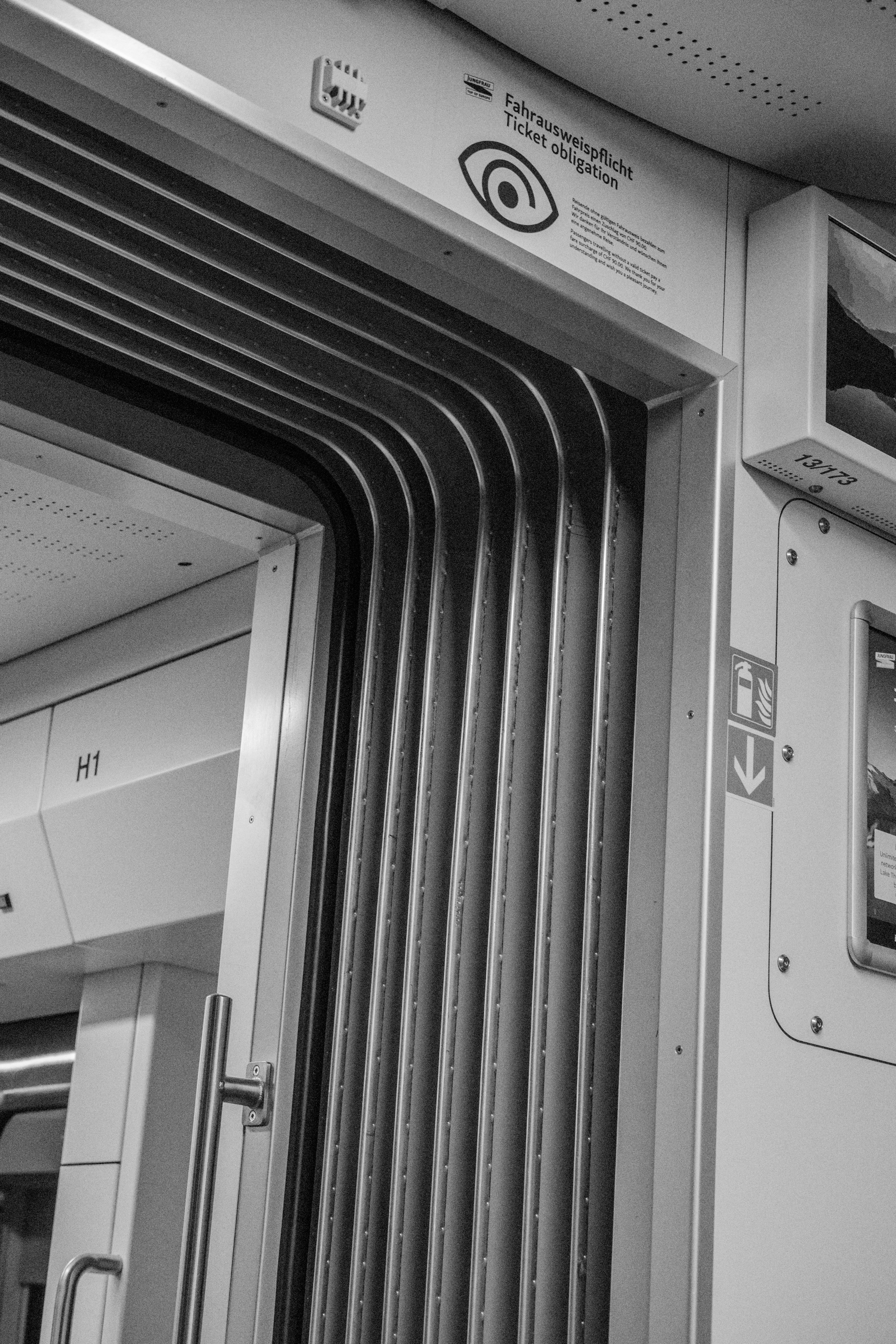 Industrial Curve: A Train Car Doorway Framed by Repeating Ribs