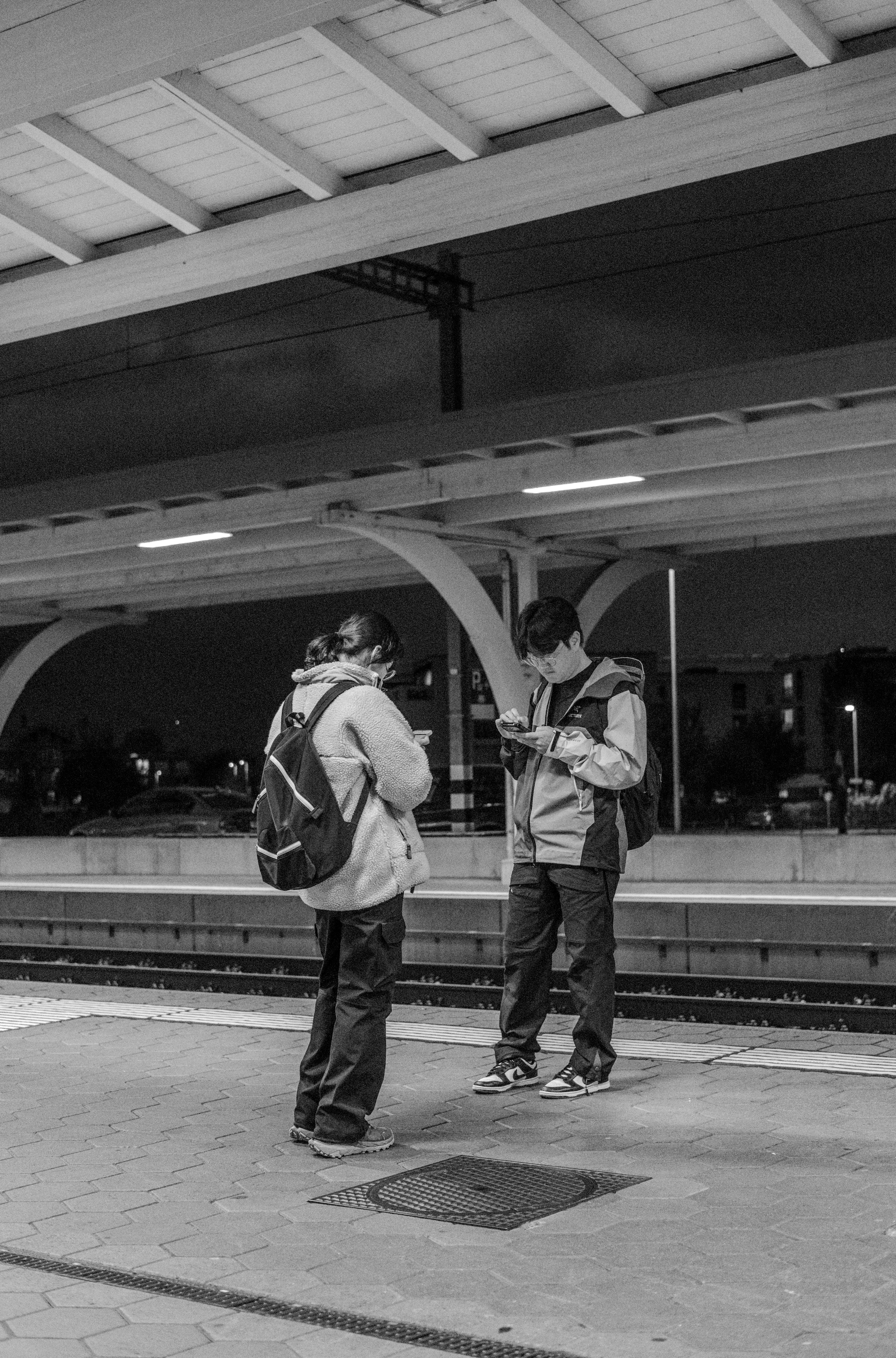 Quiet Exchange on the Platform: Two Travelers Shared in the Night