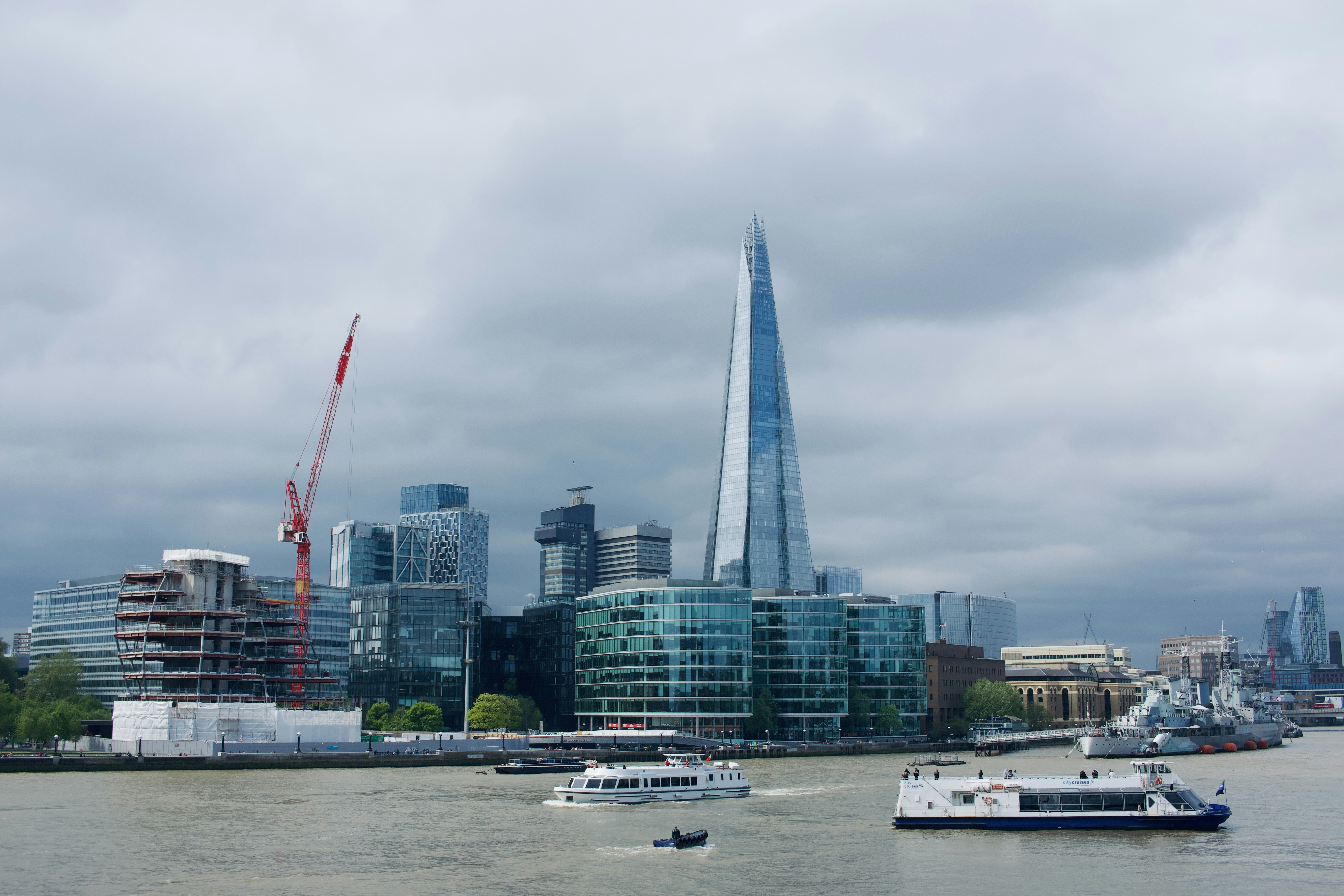 Towering Focus: City Skyline and River Craft