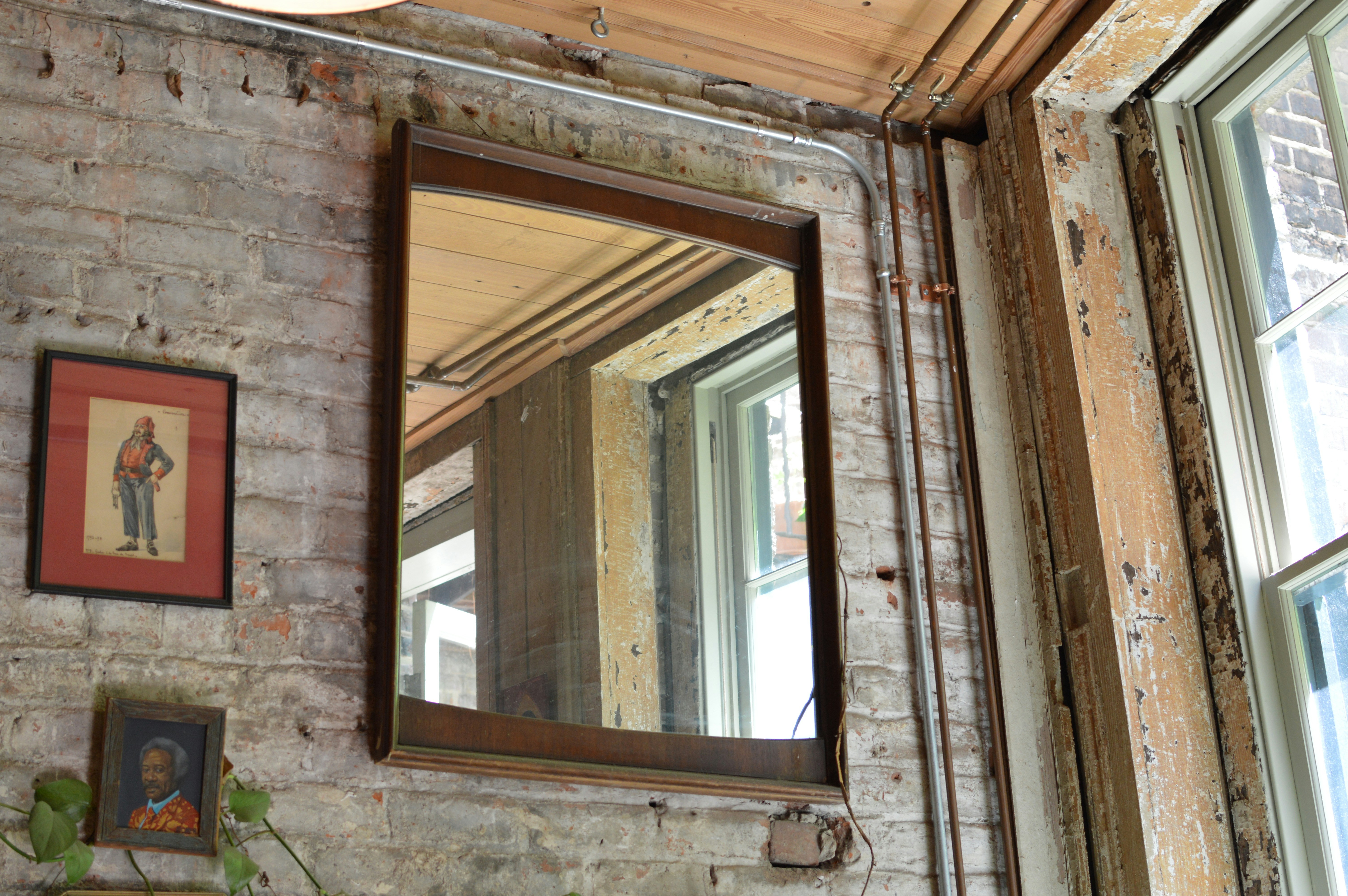 Vintage Brick Wall and Hanging Mirror in Sunlit Loft