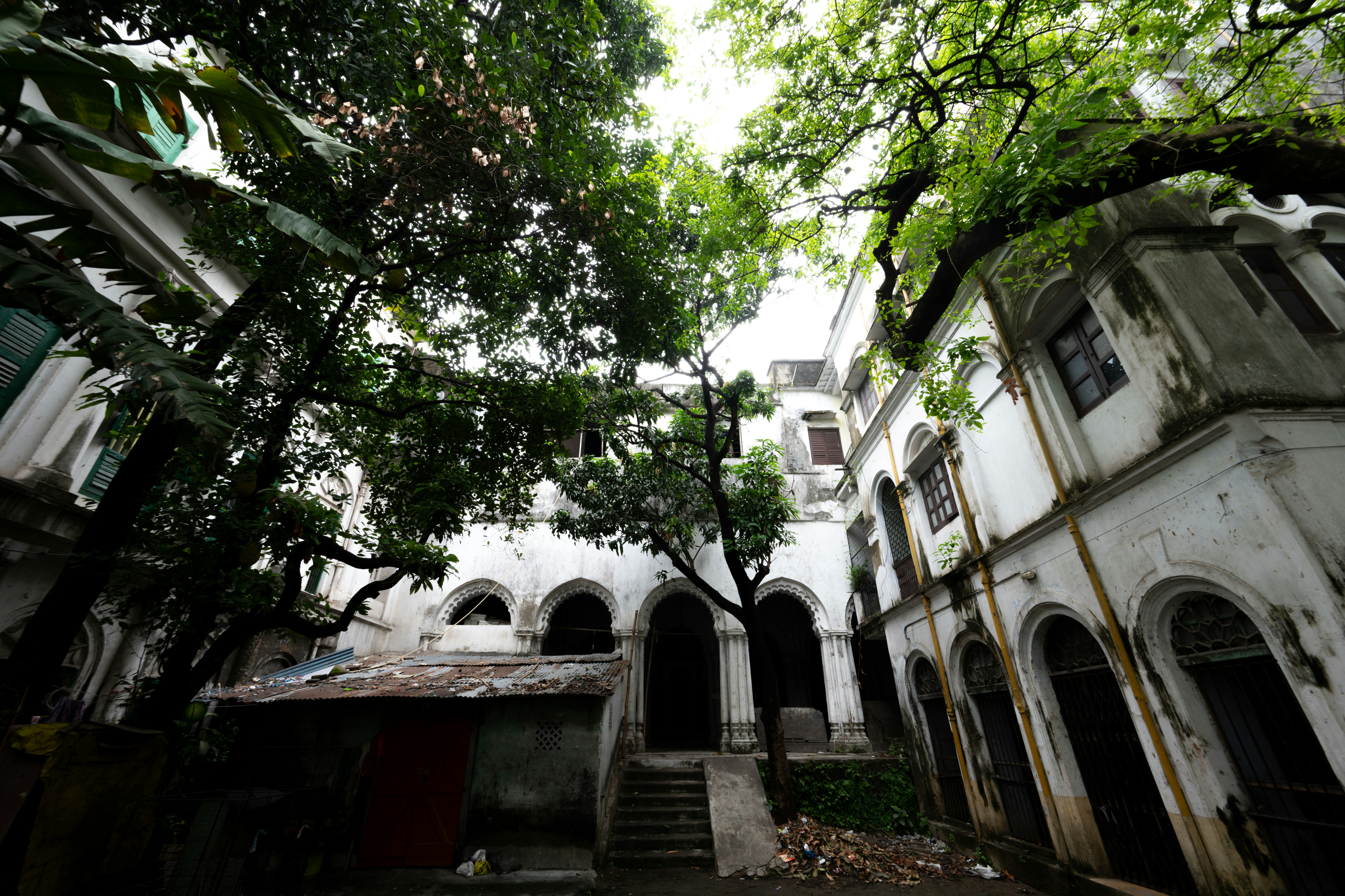Courtyard of Echoes: A Weathered Monochrome of Arched Silence