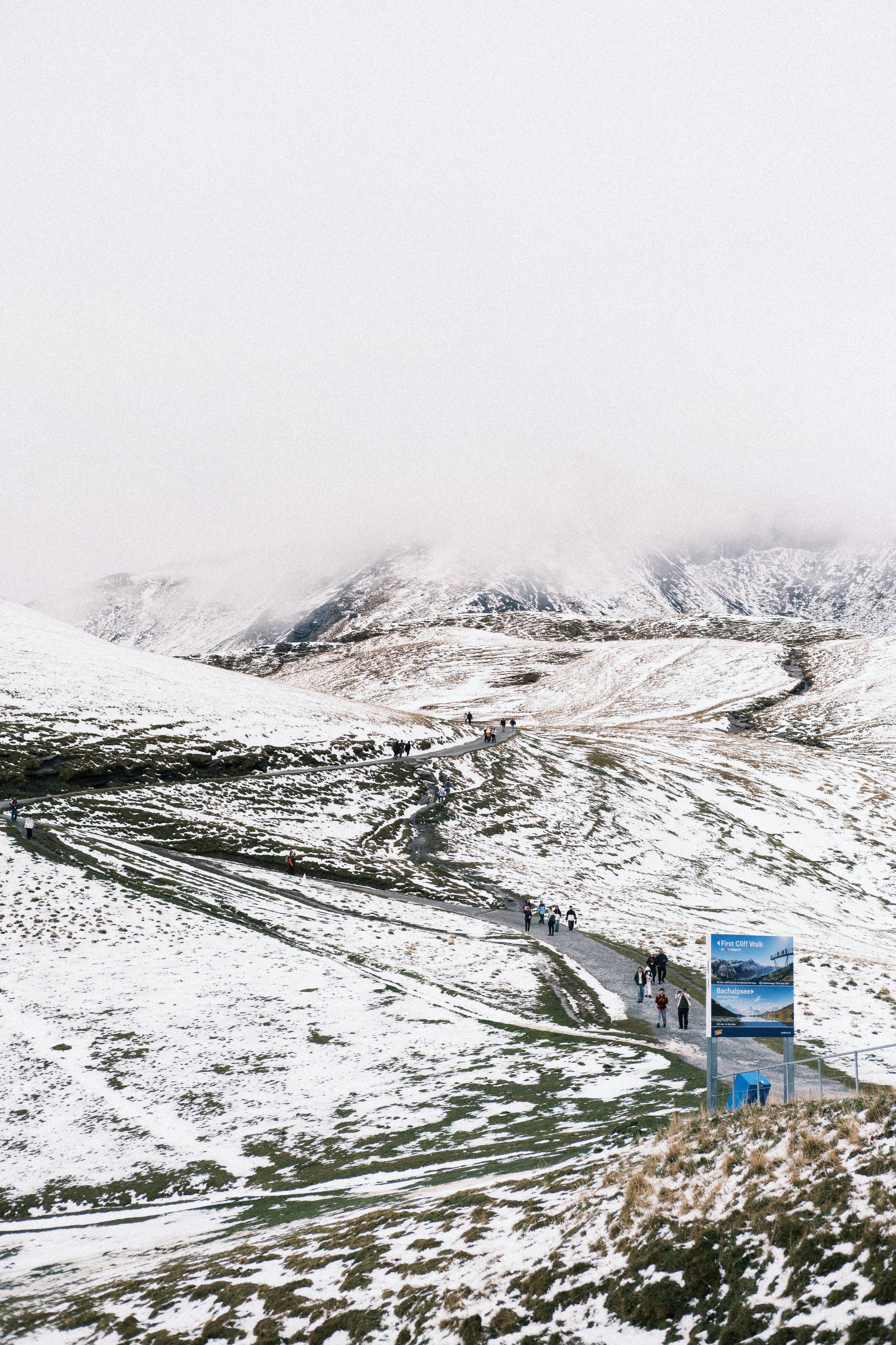 Snowbound Trail: A Quiet Ascent Beneath Misty Peaks
