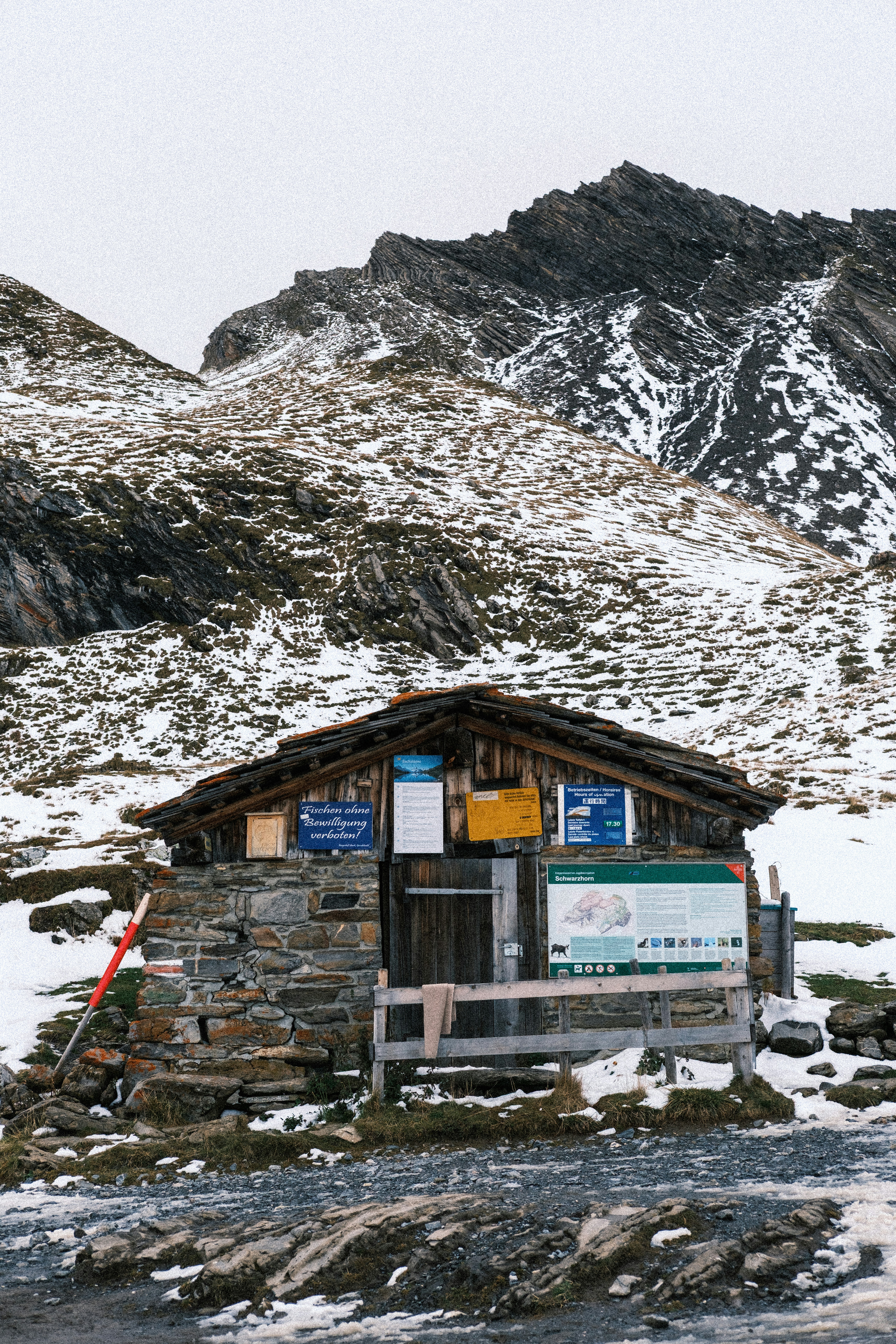 Snowbound Hut Beneath Jagged Peaks