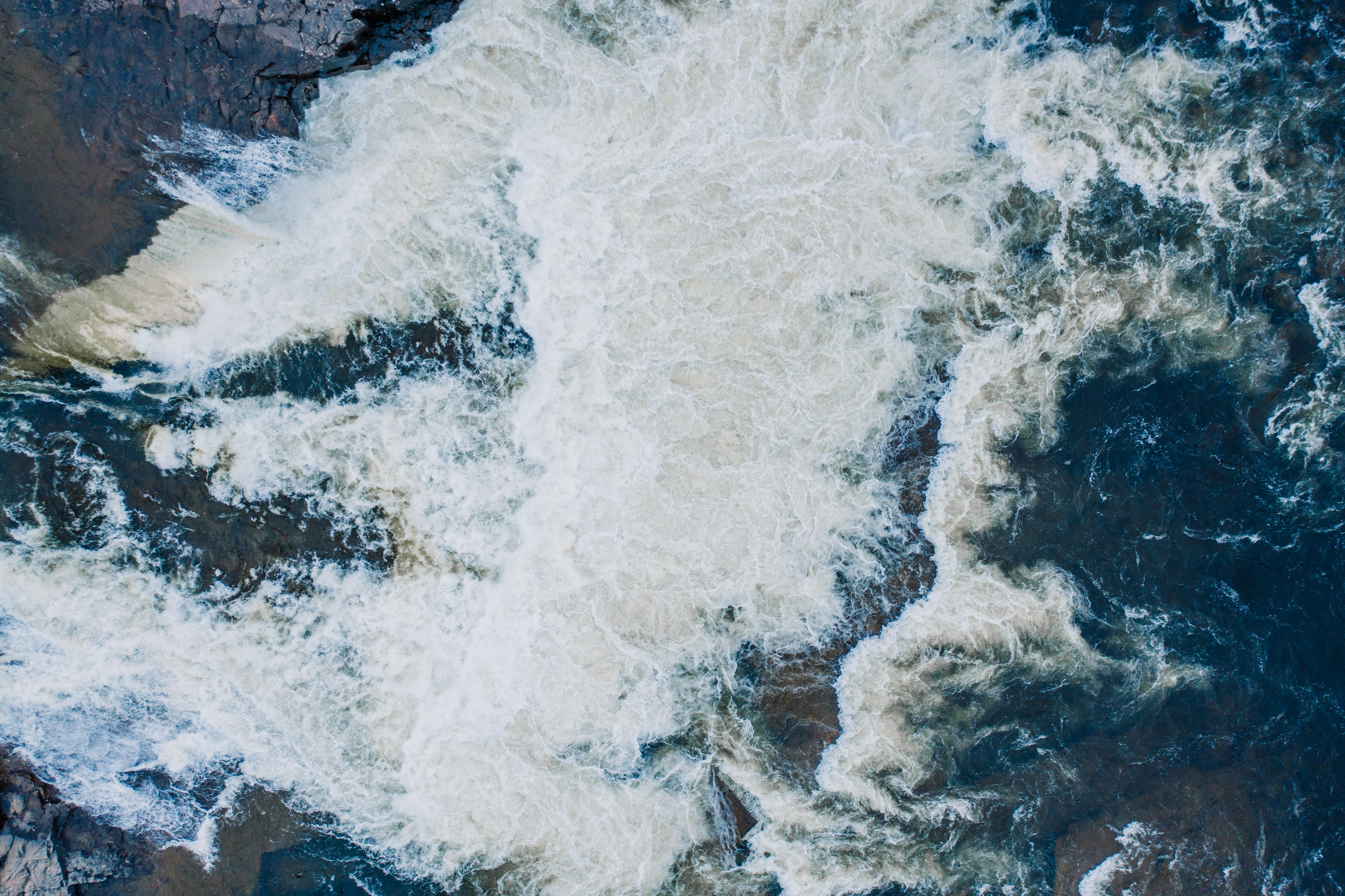 White-Curled Waves over Dark Reef: An Aerial Surge