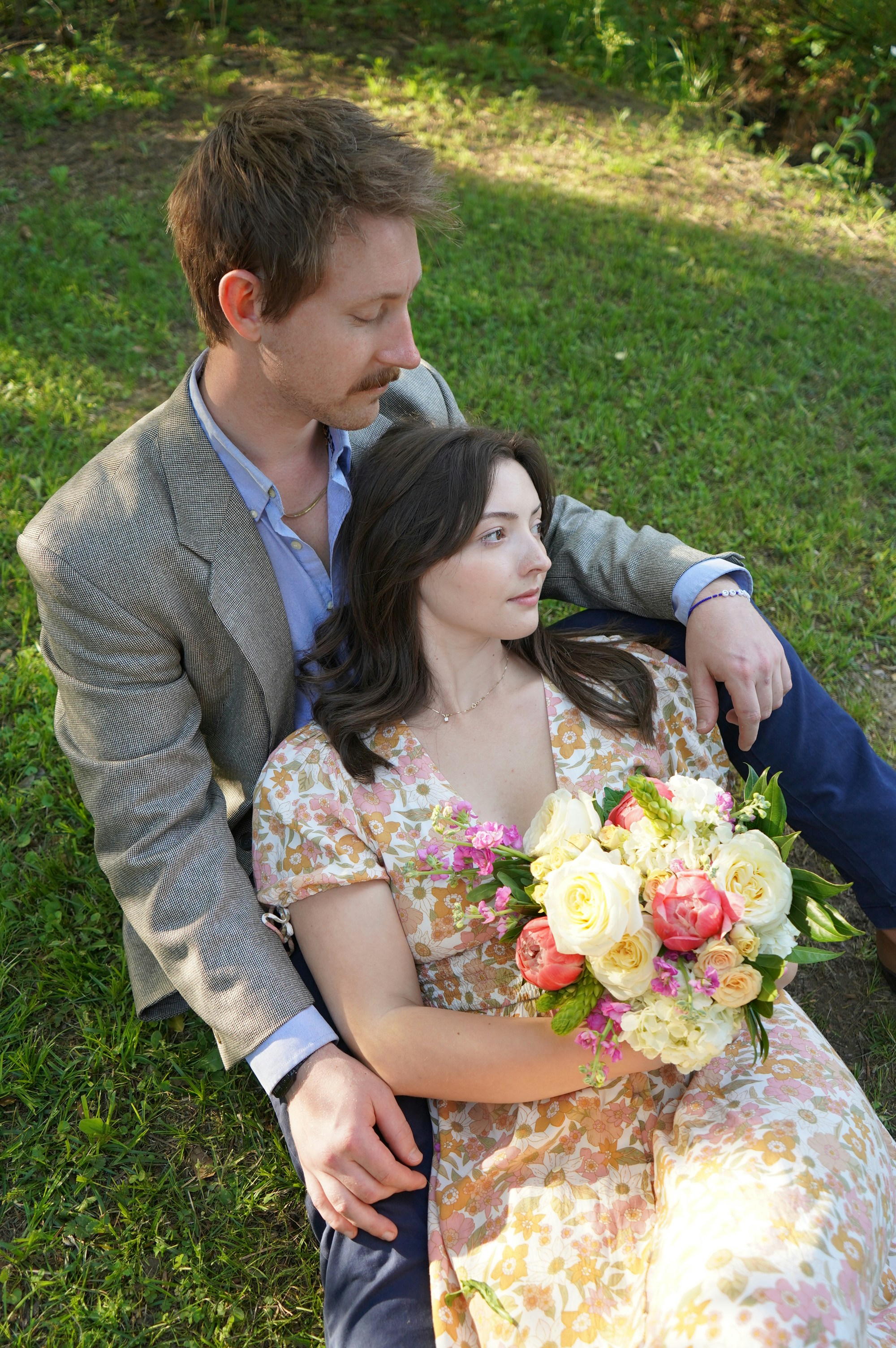 A Quiet Moment: Bride Repose with Groom in Sunlit Meadow
