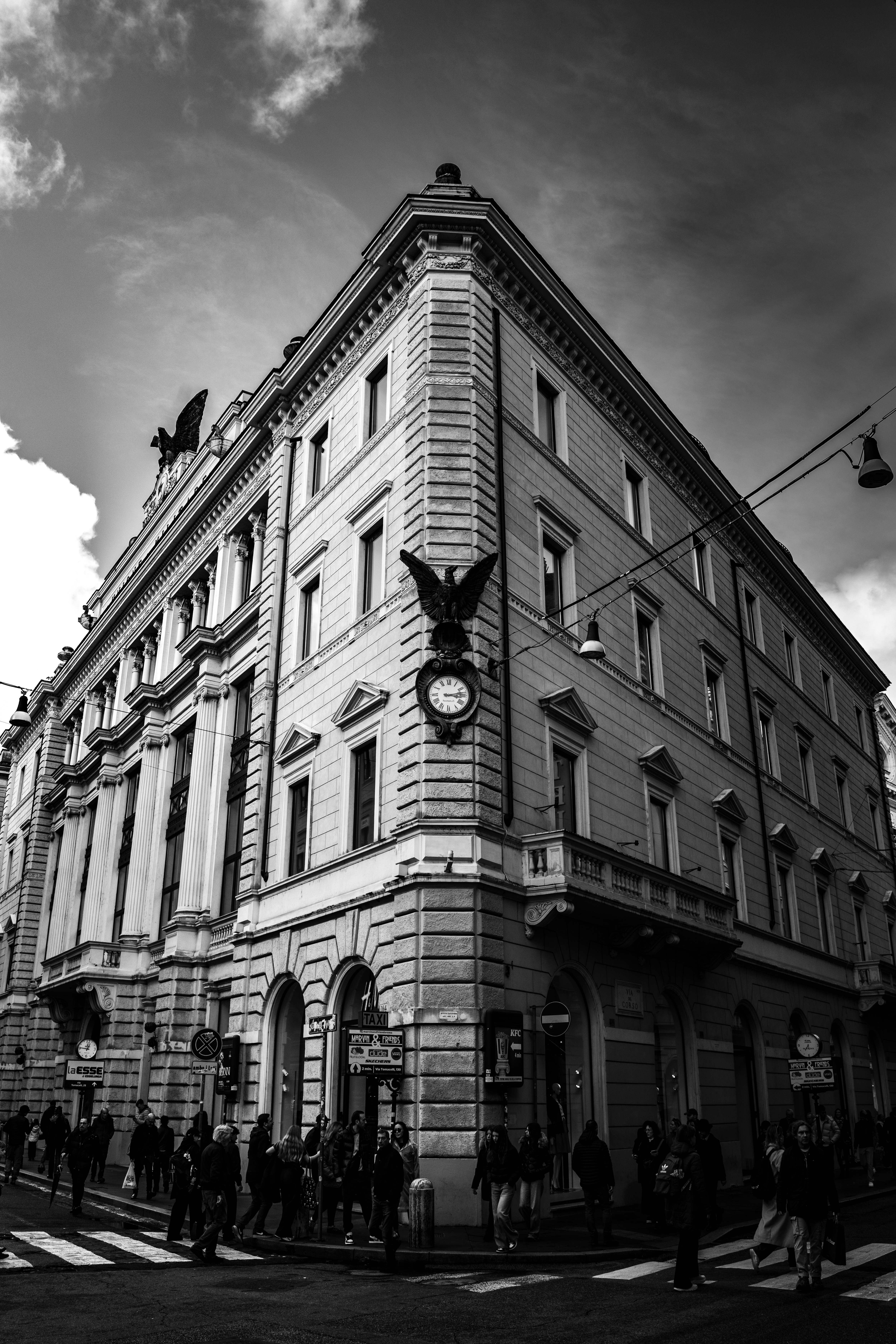 Corner Sentinel: A Cornerstone Building with Clock and Winged Emblems