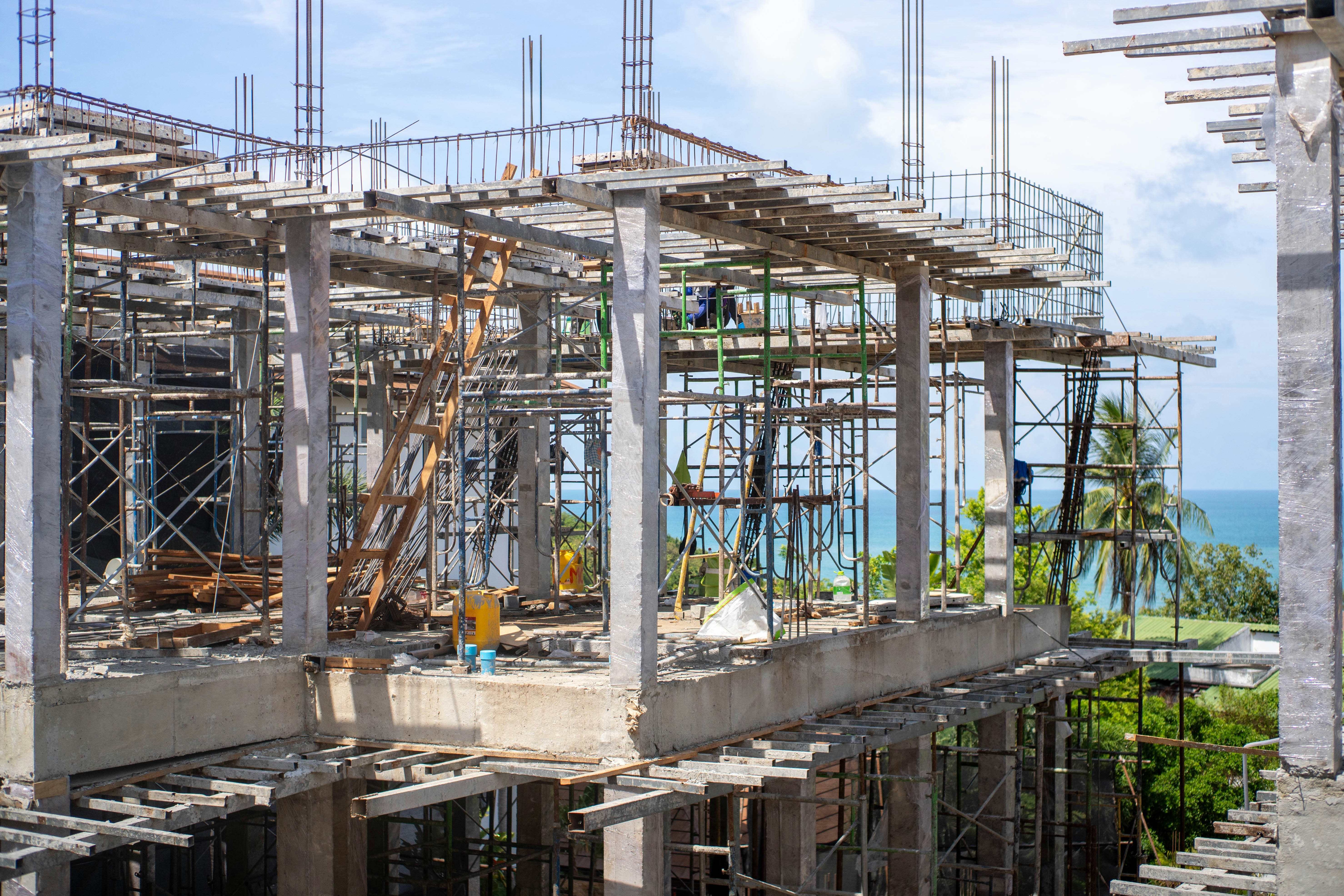 Ribbed Skeleton: Concrete Framework Rising Over Coastal Scenery