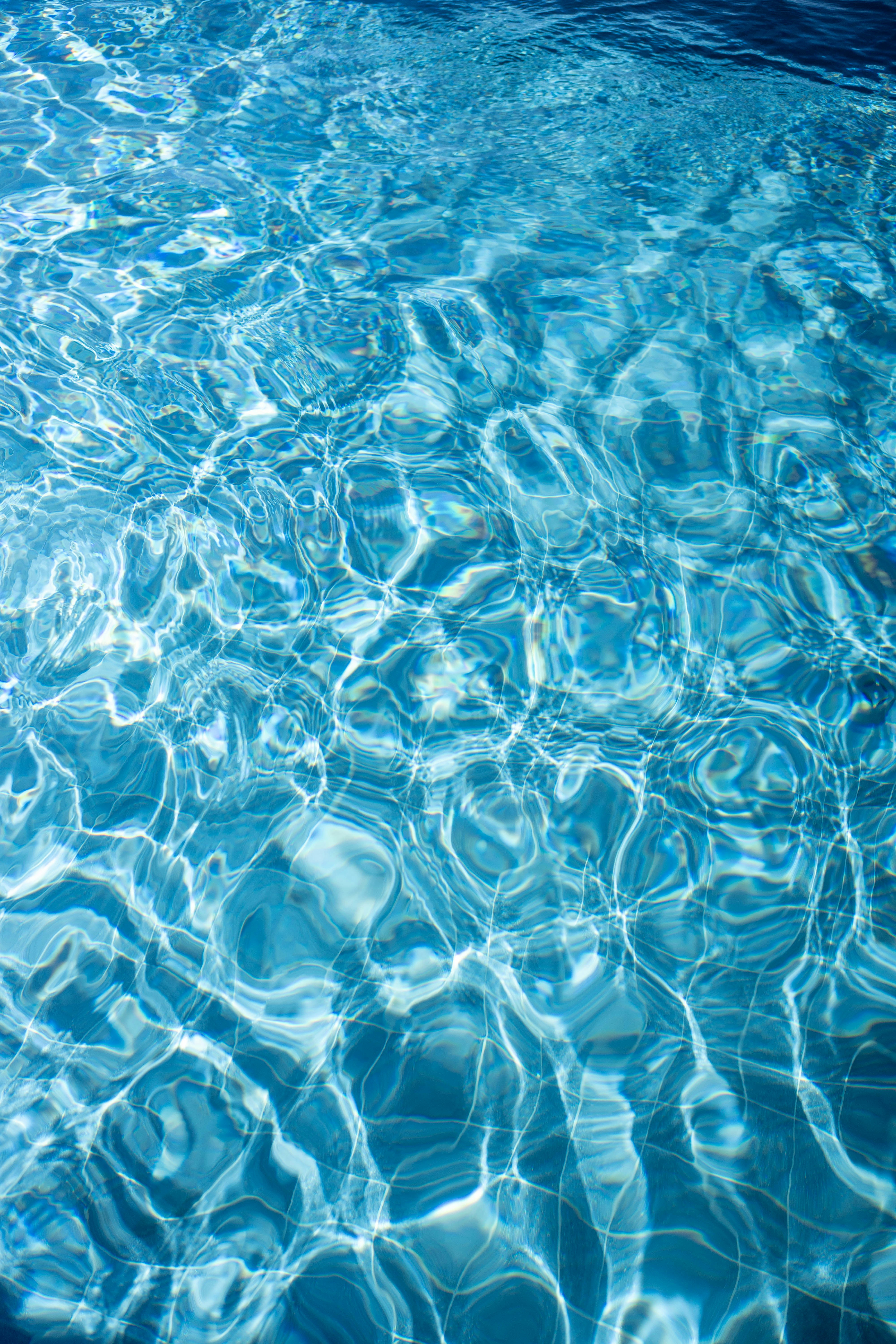 Liquid Mosaic: Sunlit Ripples on Pristine Pool Surface