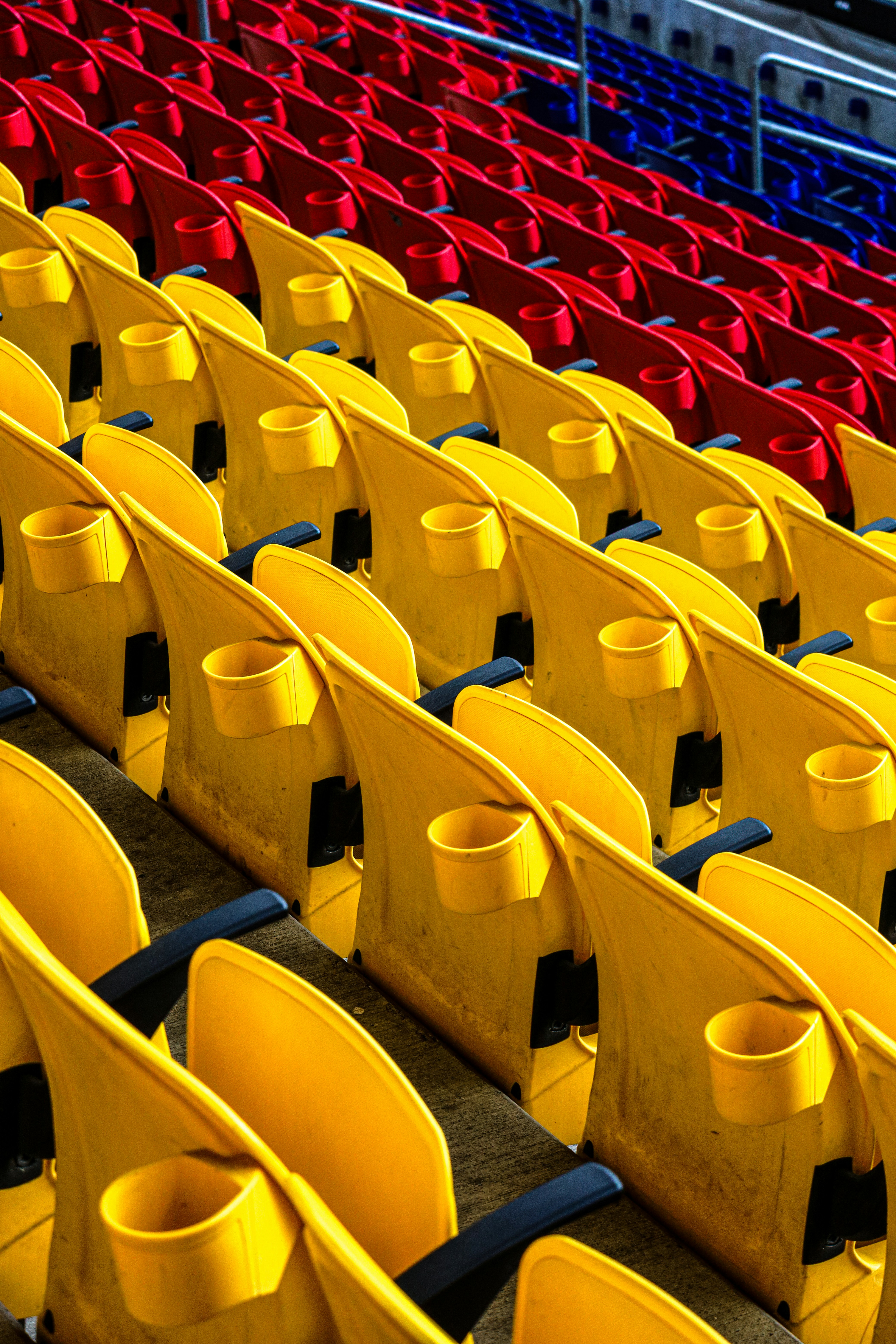 Consecutive Rows of Yellow Seats Burn Bright Amid Red and Blue Tiers