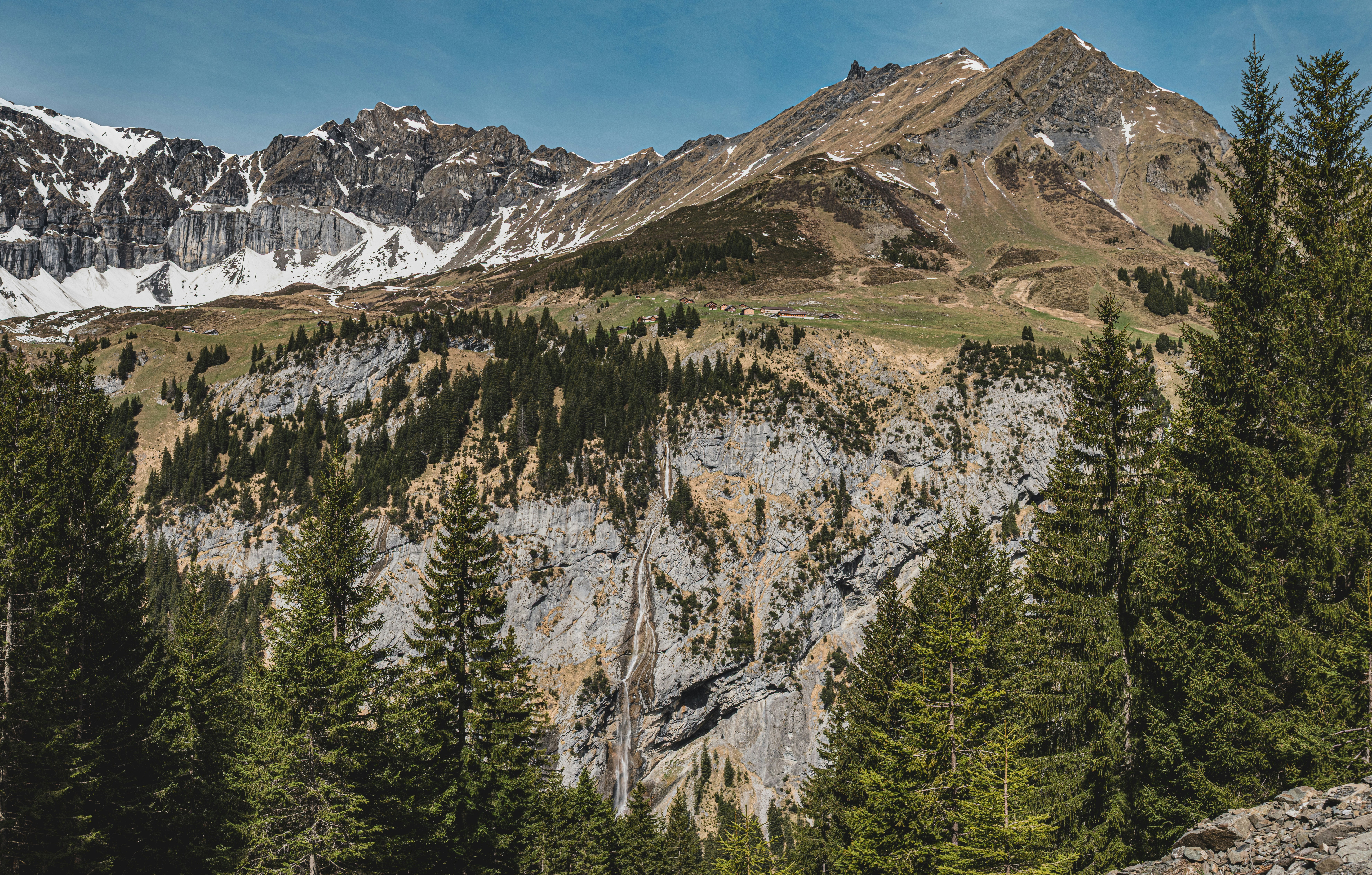 Snow-dusted Peaks Loom Over Forested Valleys