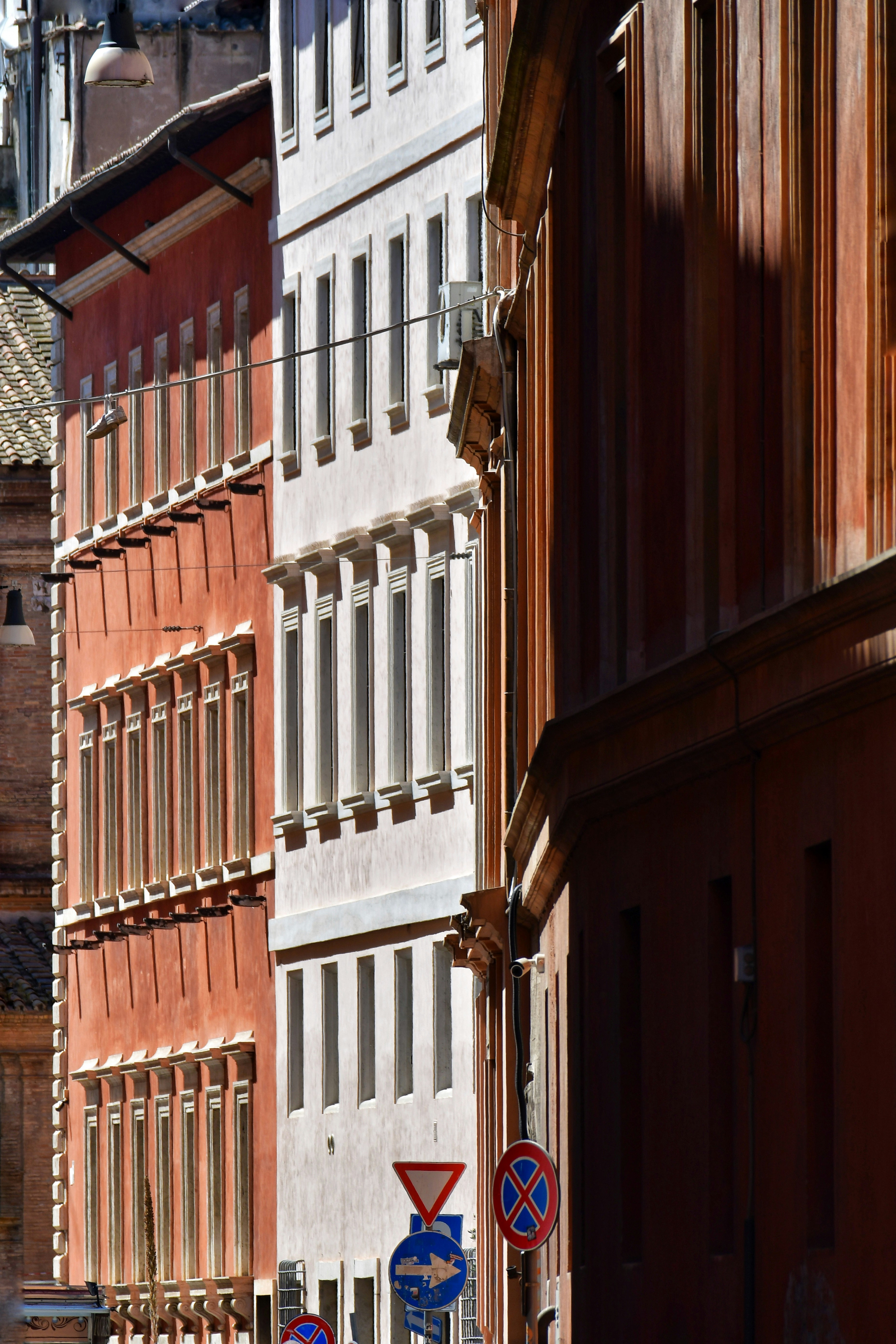 Sunlit Facades and Painted Echoes Along a Narrow European Street