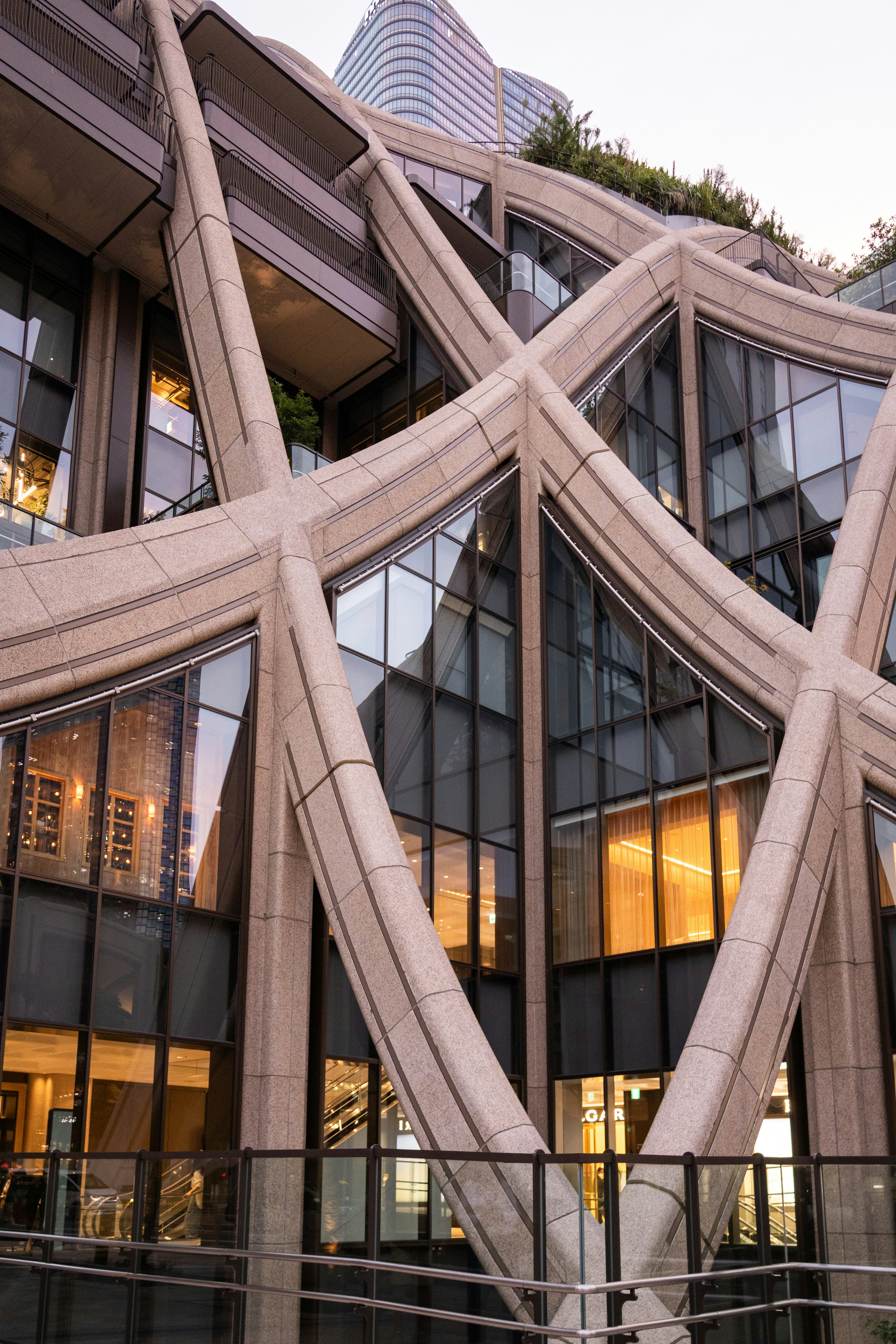Crisscrossed Concrete: A Faceted Facade Reaching Toward the Sky