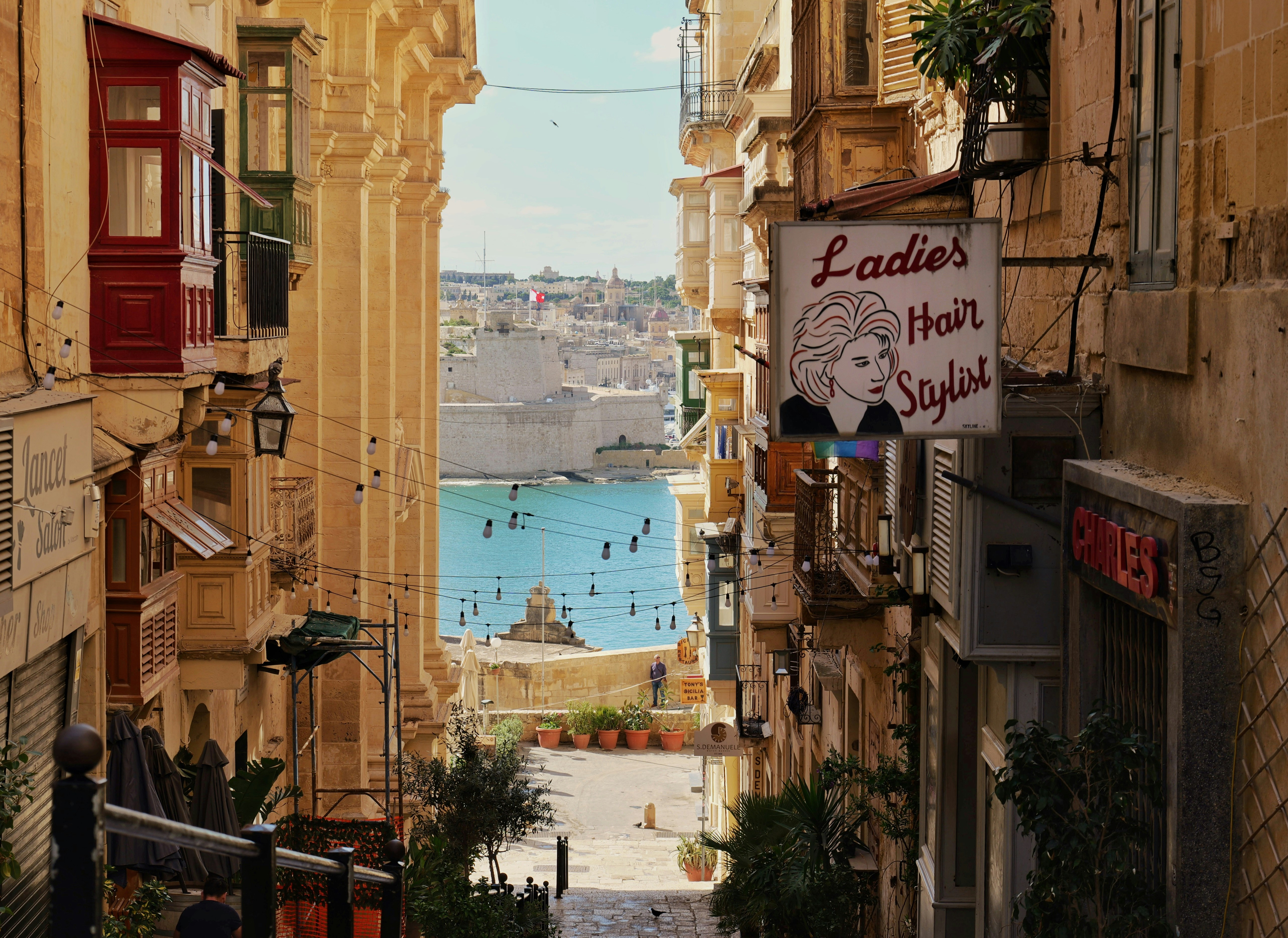 Staircase to the Sea: Sunlit Alley Framing Valletta’s Harbor