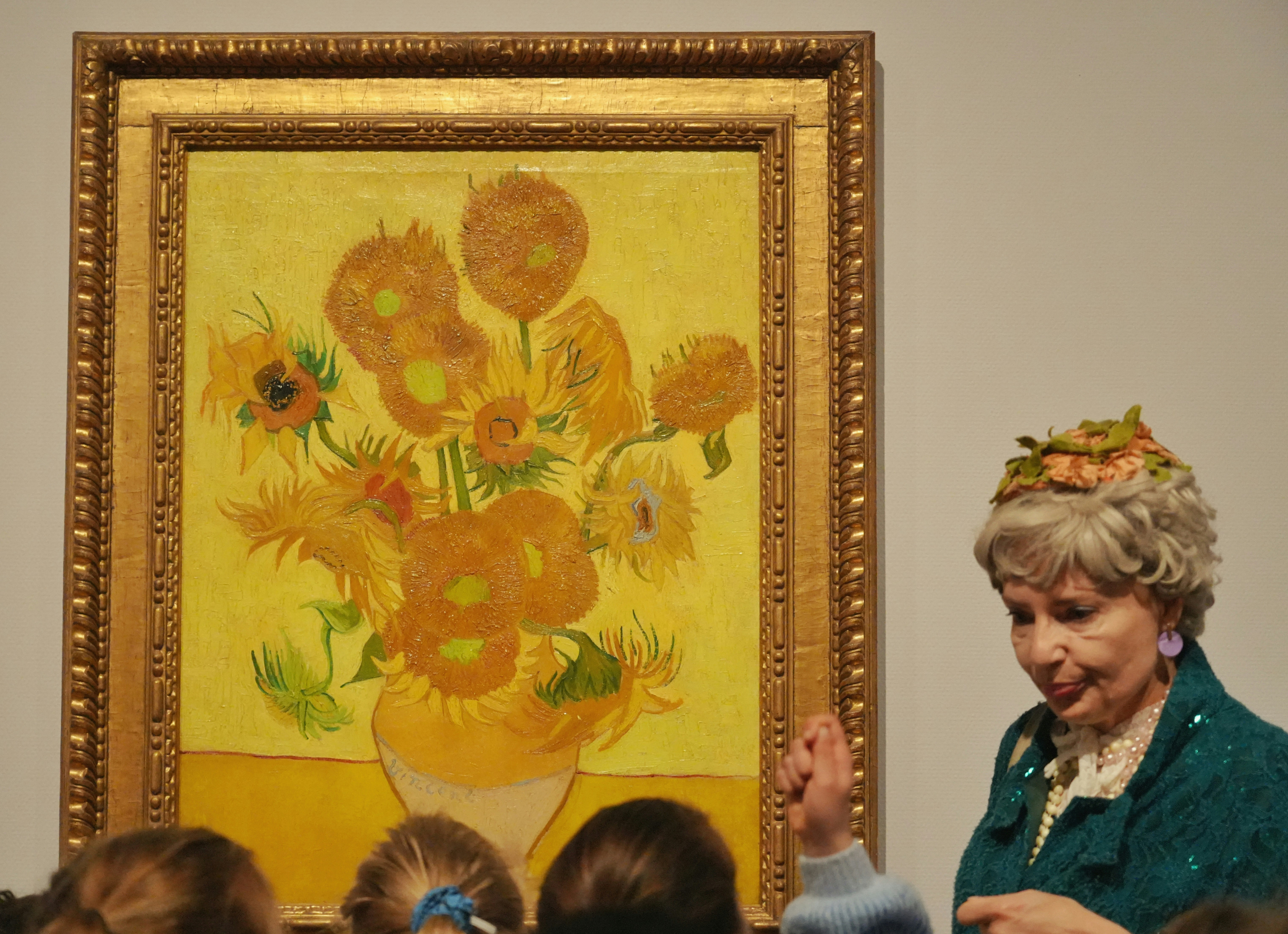 Sunflowers in a Golden Frame: A Quiet Moment with the Elderly Speaker