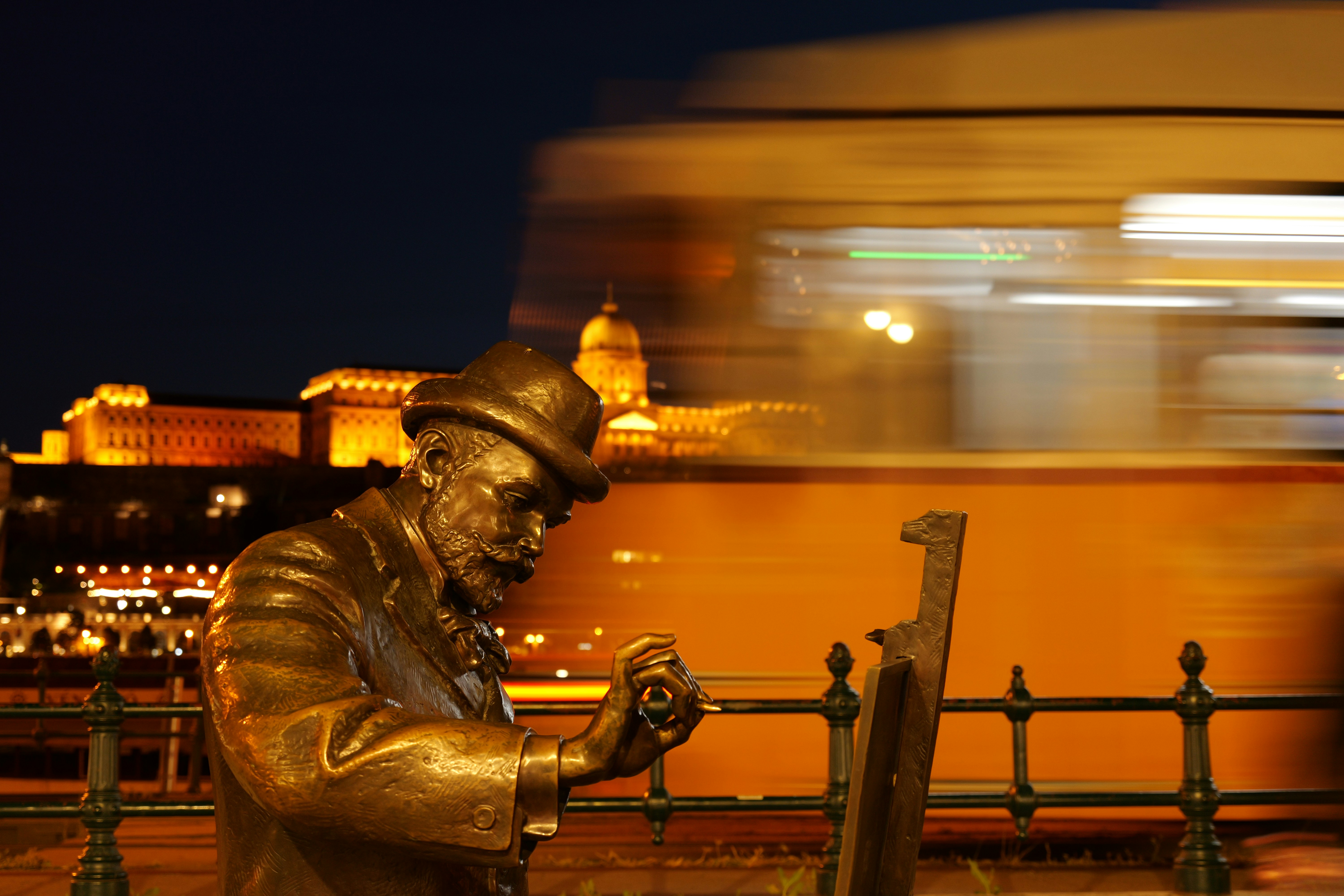 A bronze bard in motion: a night-by-the-bridge portrait