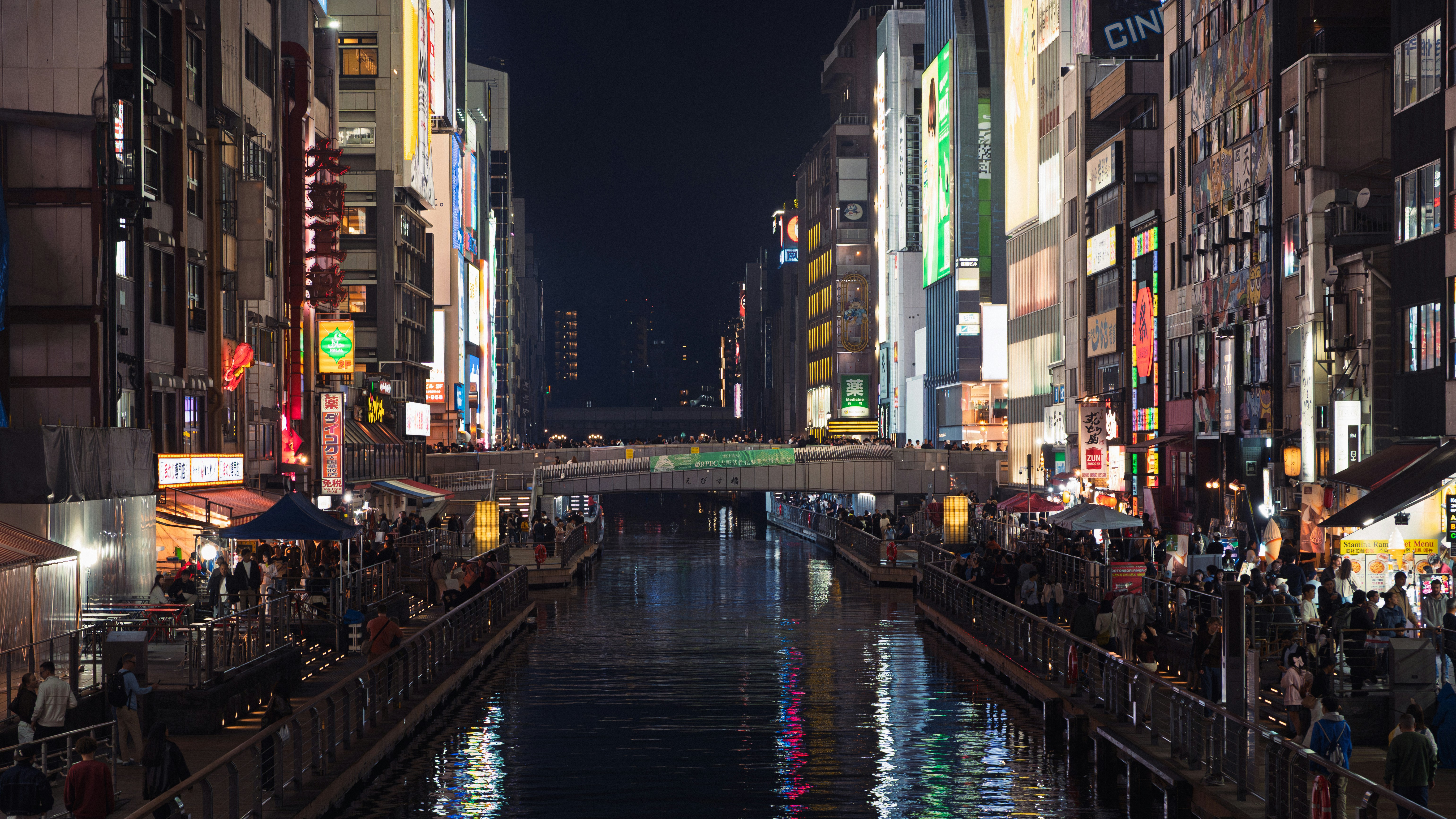 Neon Reflections Along a Nighttime Urban Canal
