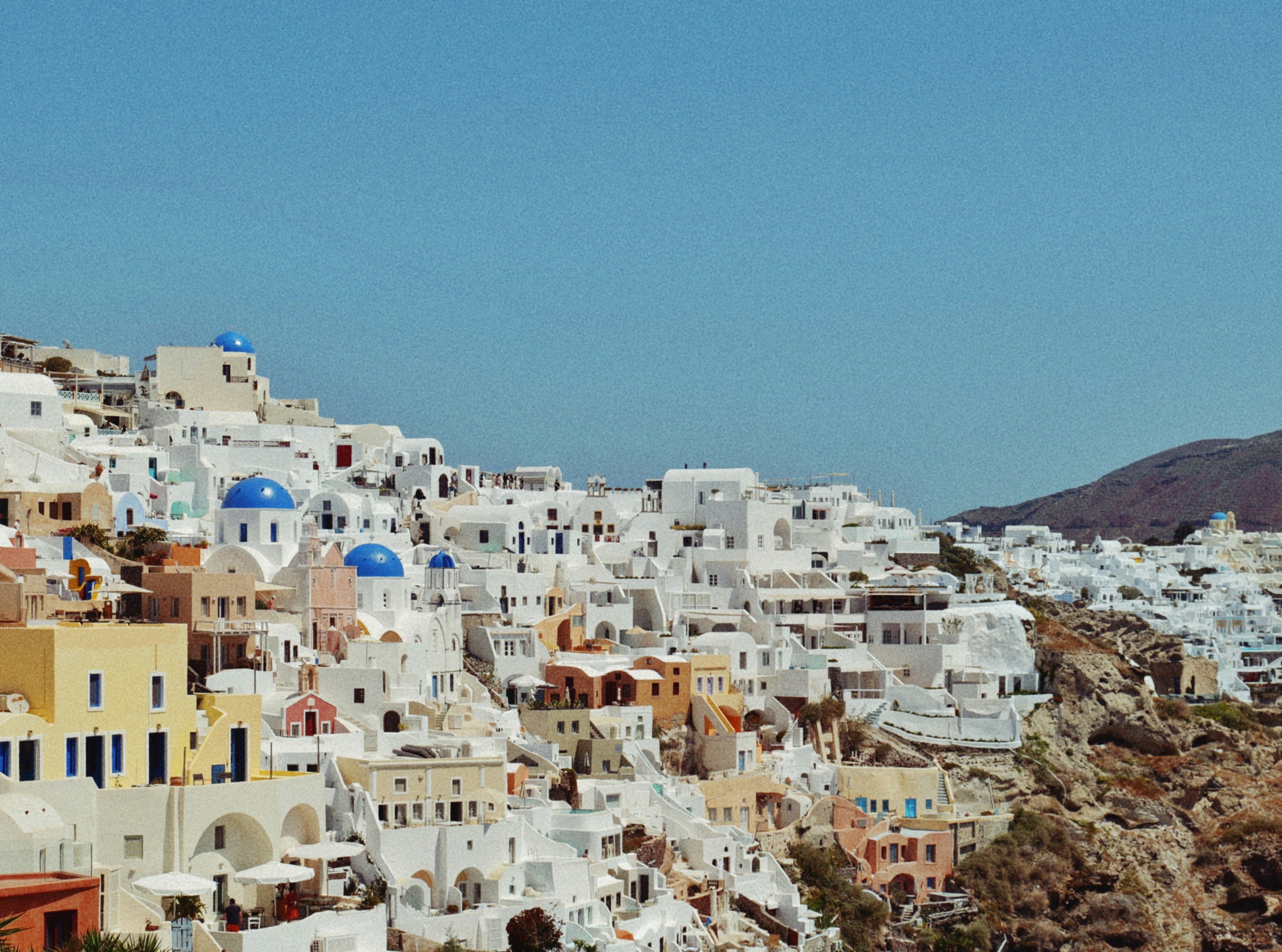 Whitewashed Hillside in Santorini with Blue Domes