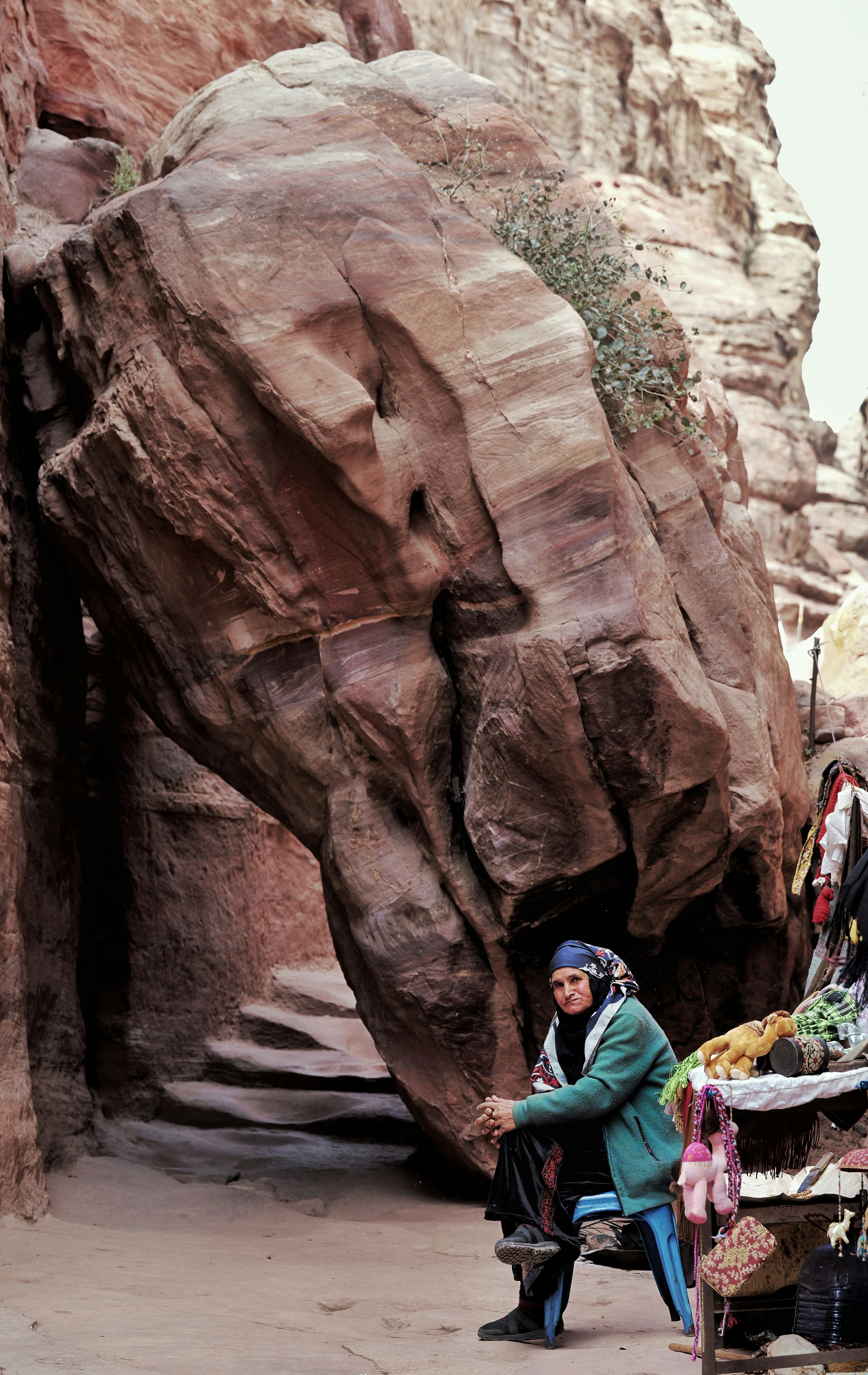 Hidden Vendor by the Canyon: A Woman and Her Stall Nestled in Red Rock