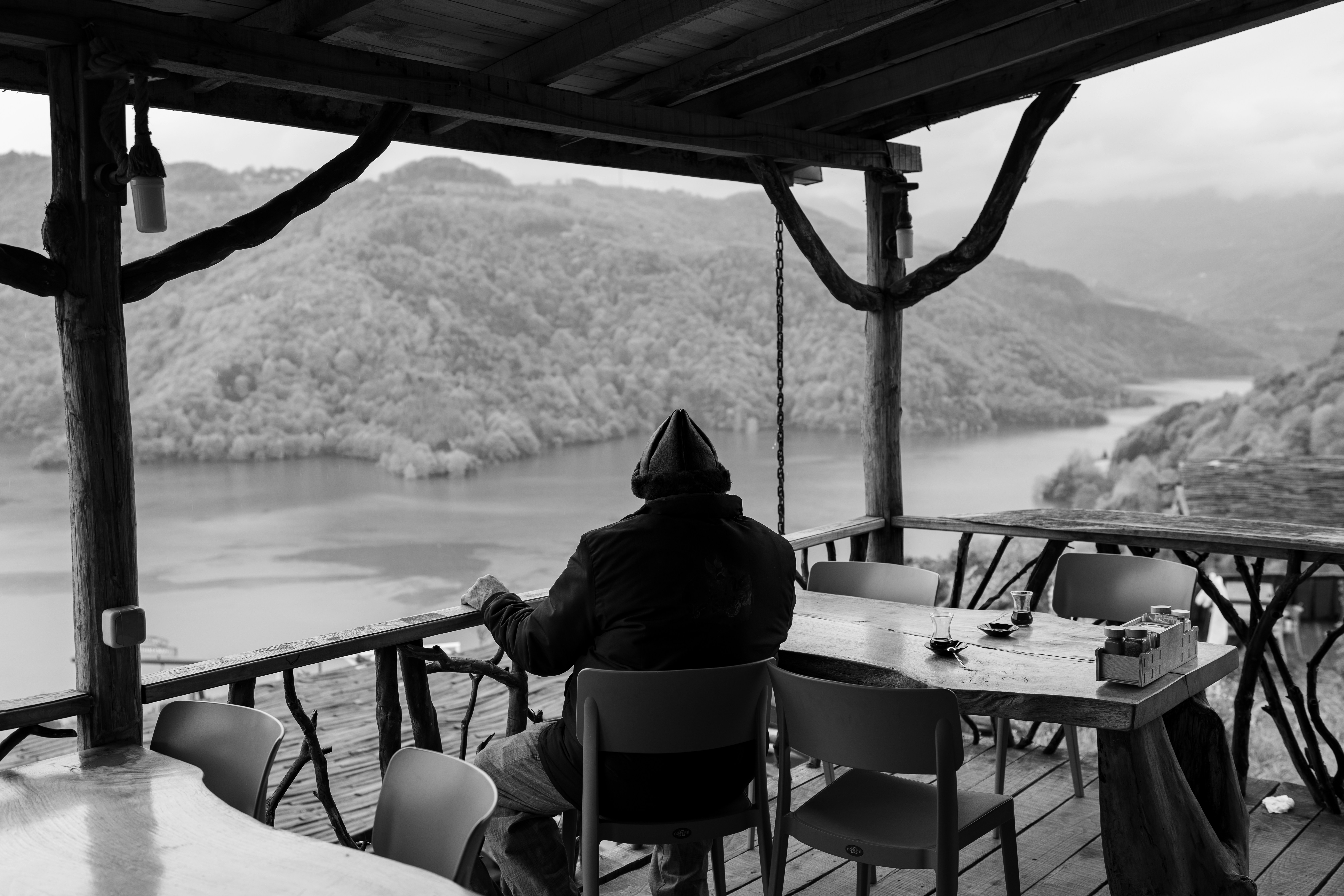 Silhouette on the Terrace: Quiet Vigil Amid Valley Echoes