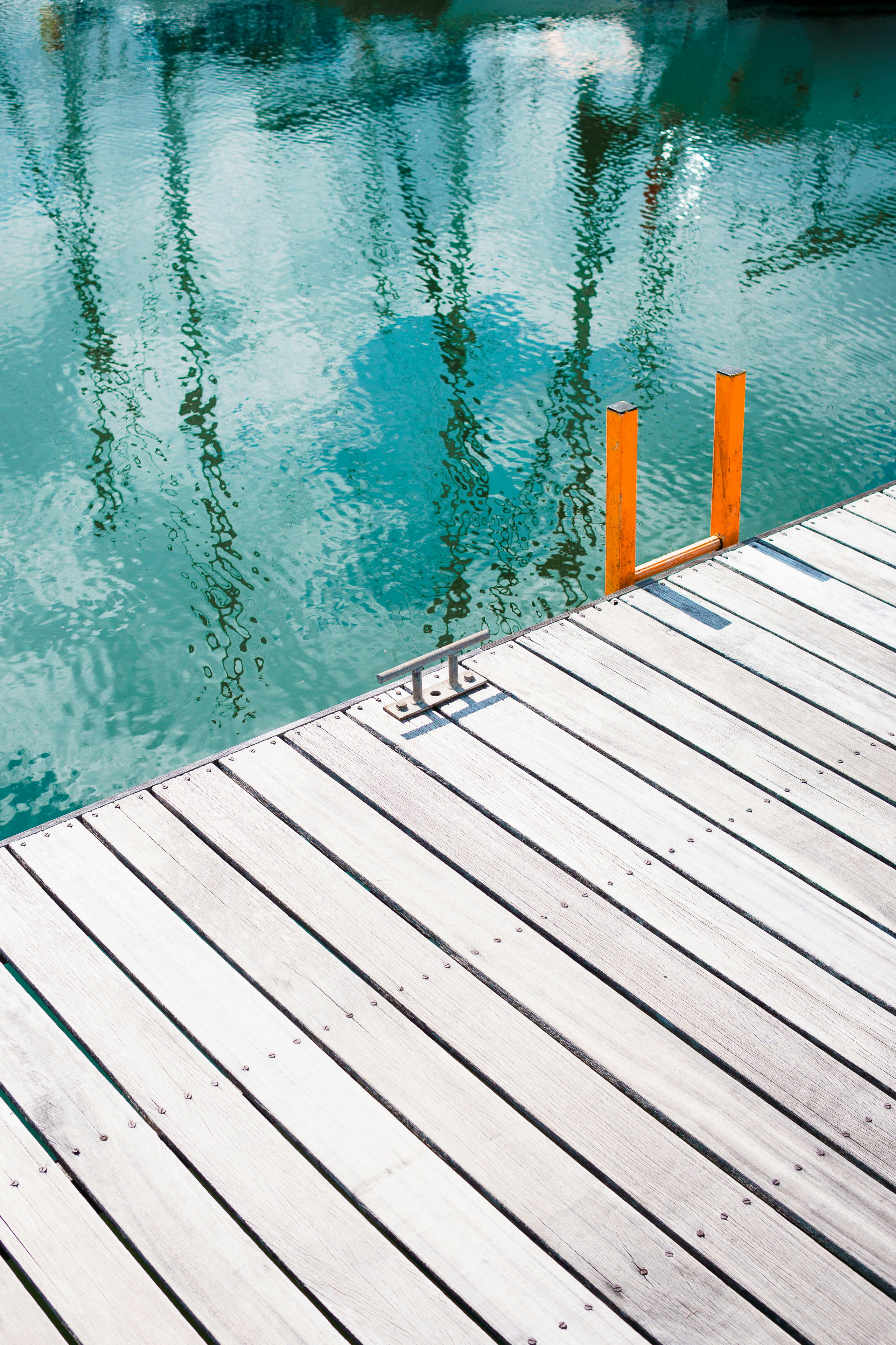 Sunlit Dock Edges and Teal Water