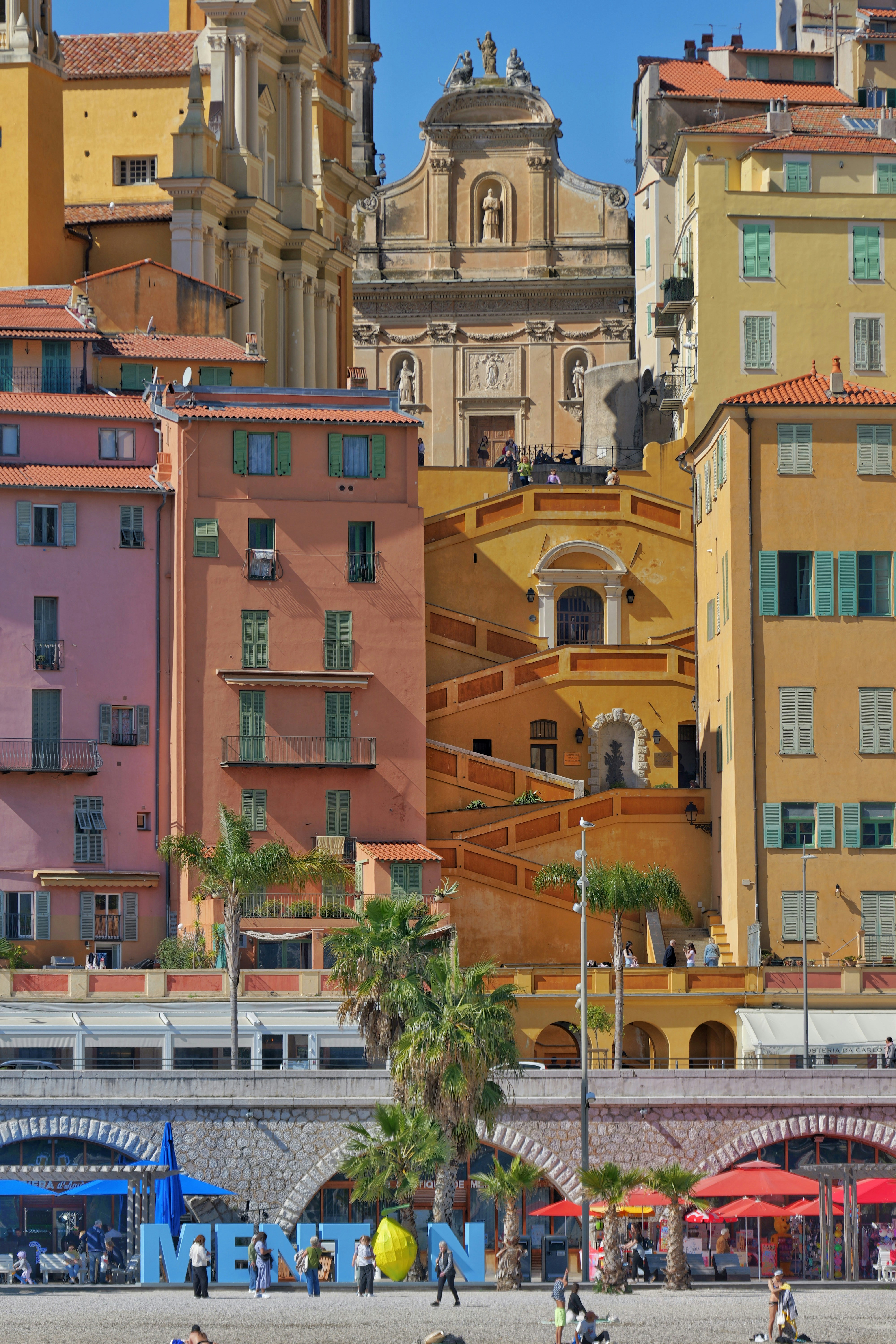 Colorful hillside stairway to a triumphal arch and church