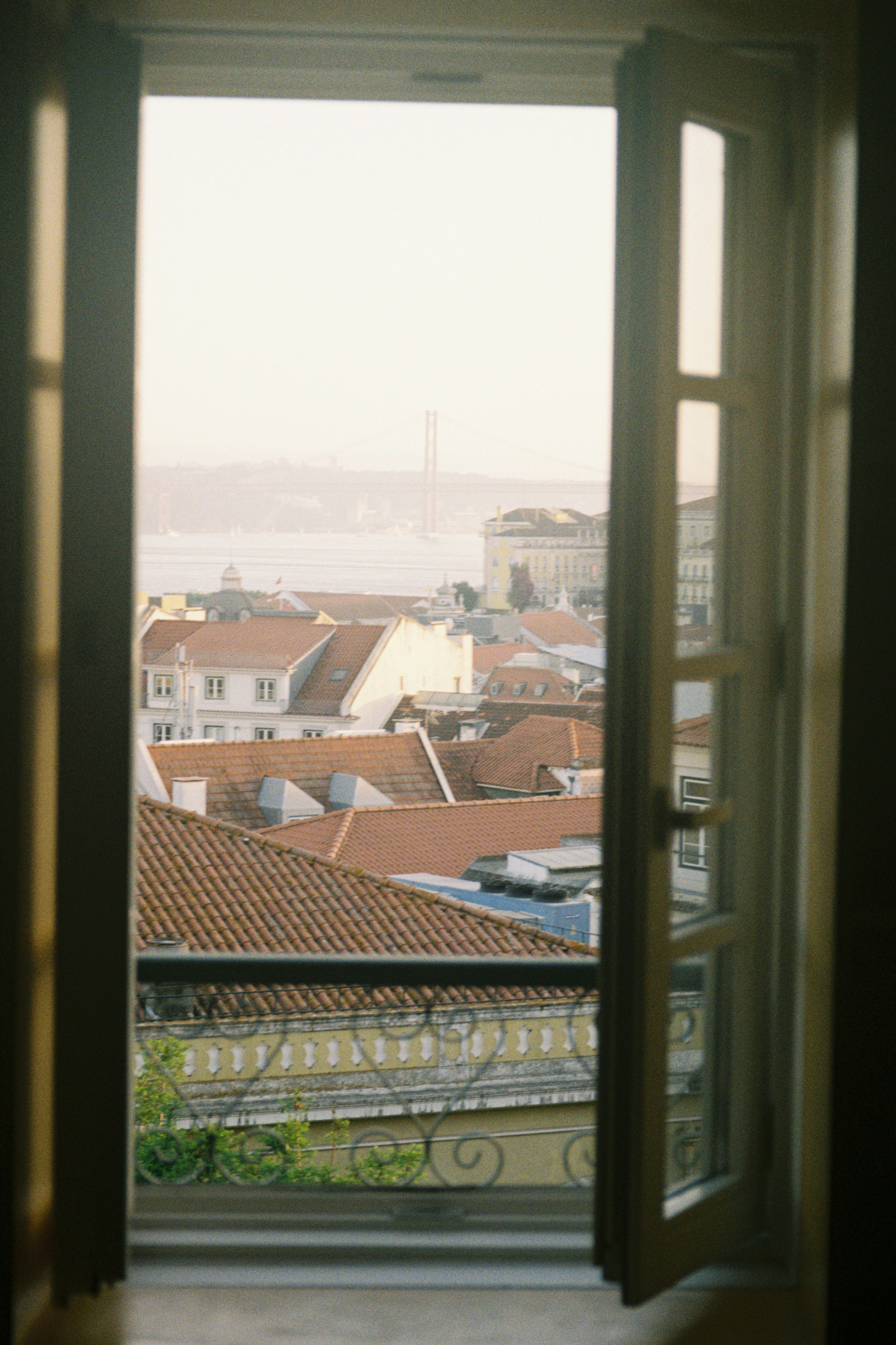 Open Window Over the Rooftops: A Soft-Hued Cityscape
