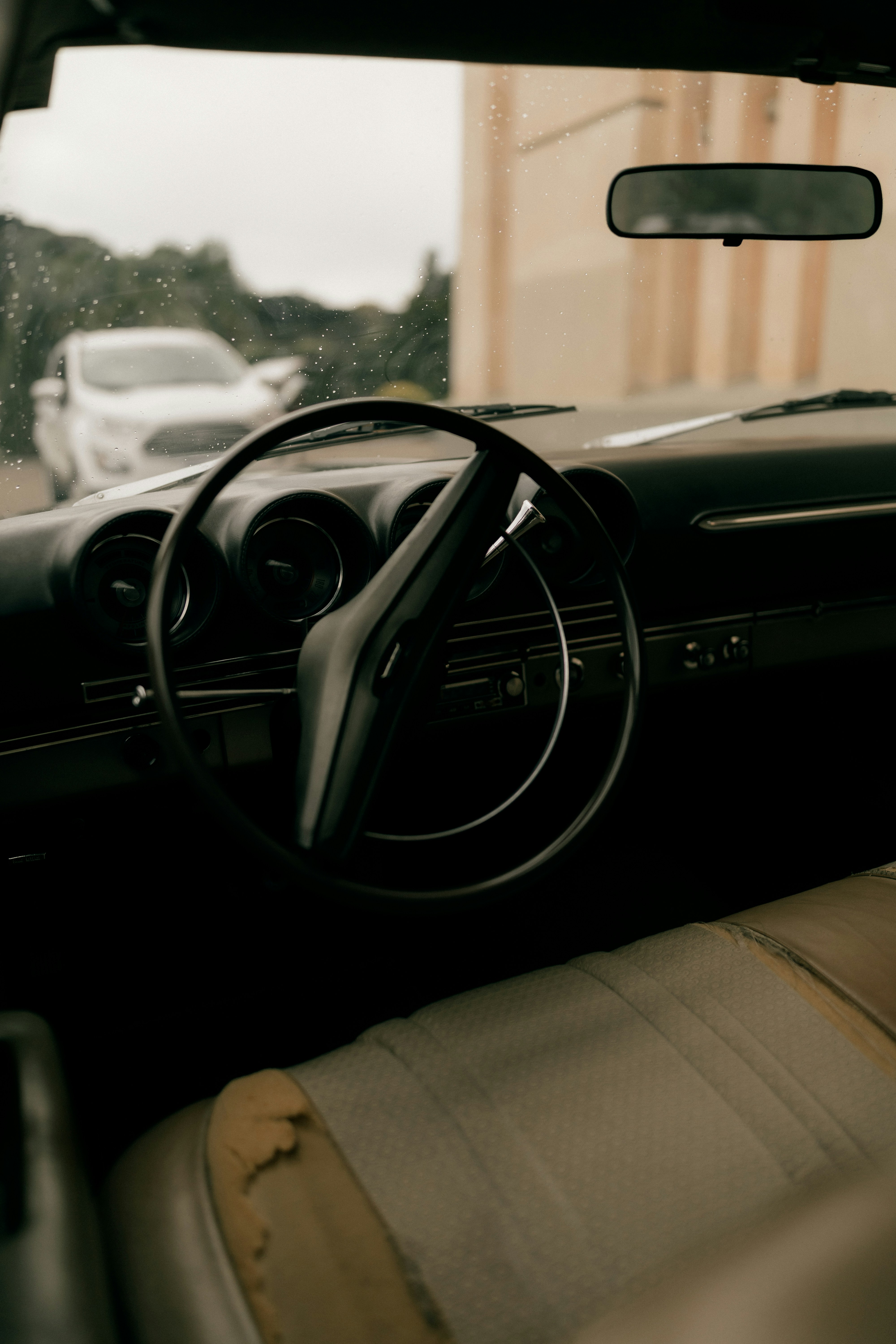 Vintage Car Interior: Worn Leather and Circular Dashboard Dashes