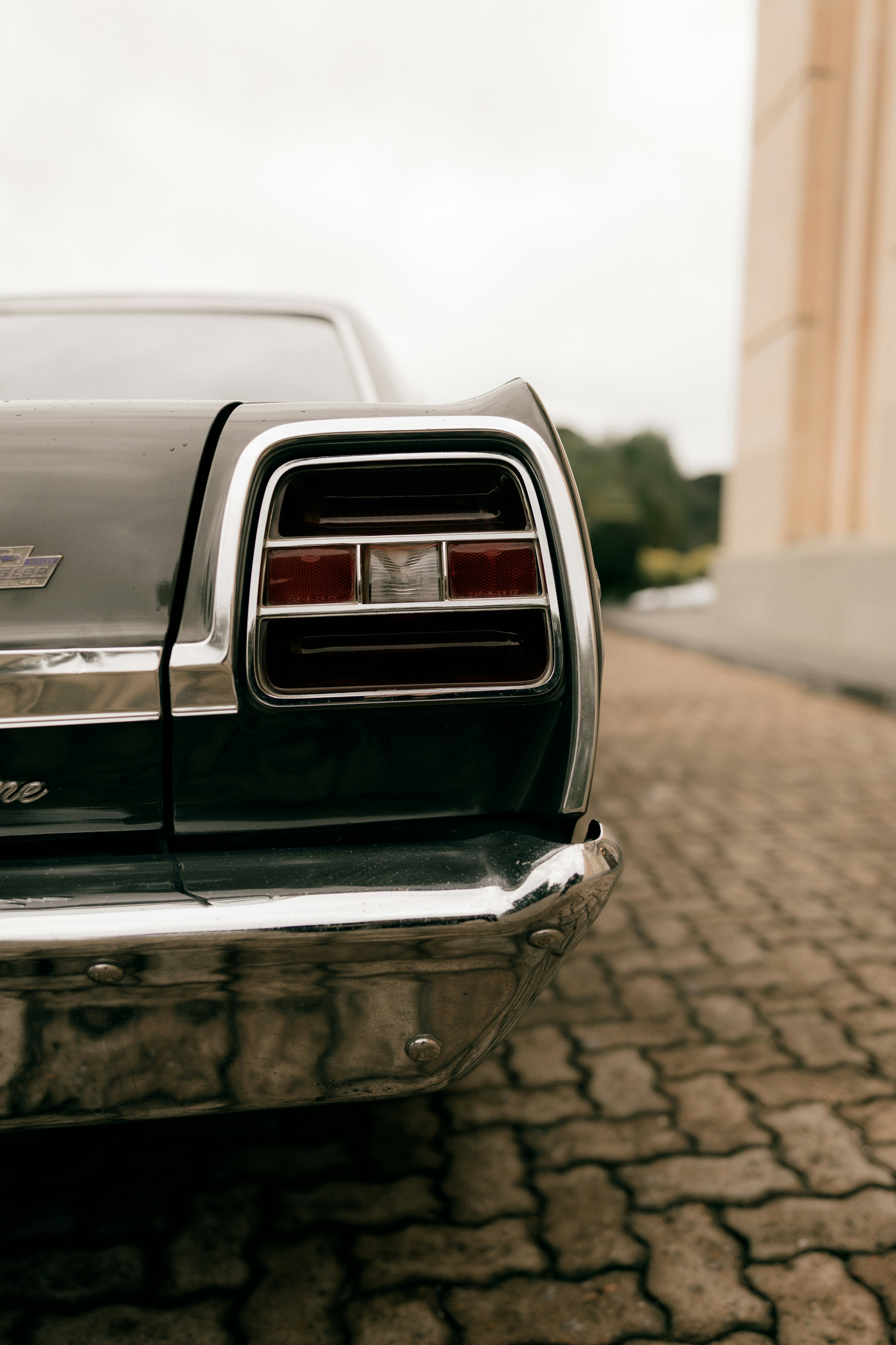 Chrome and Curves: Tail Light Era on Cobbled Quiet