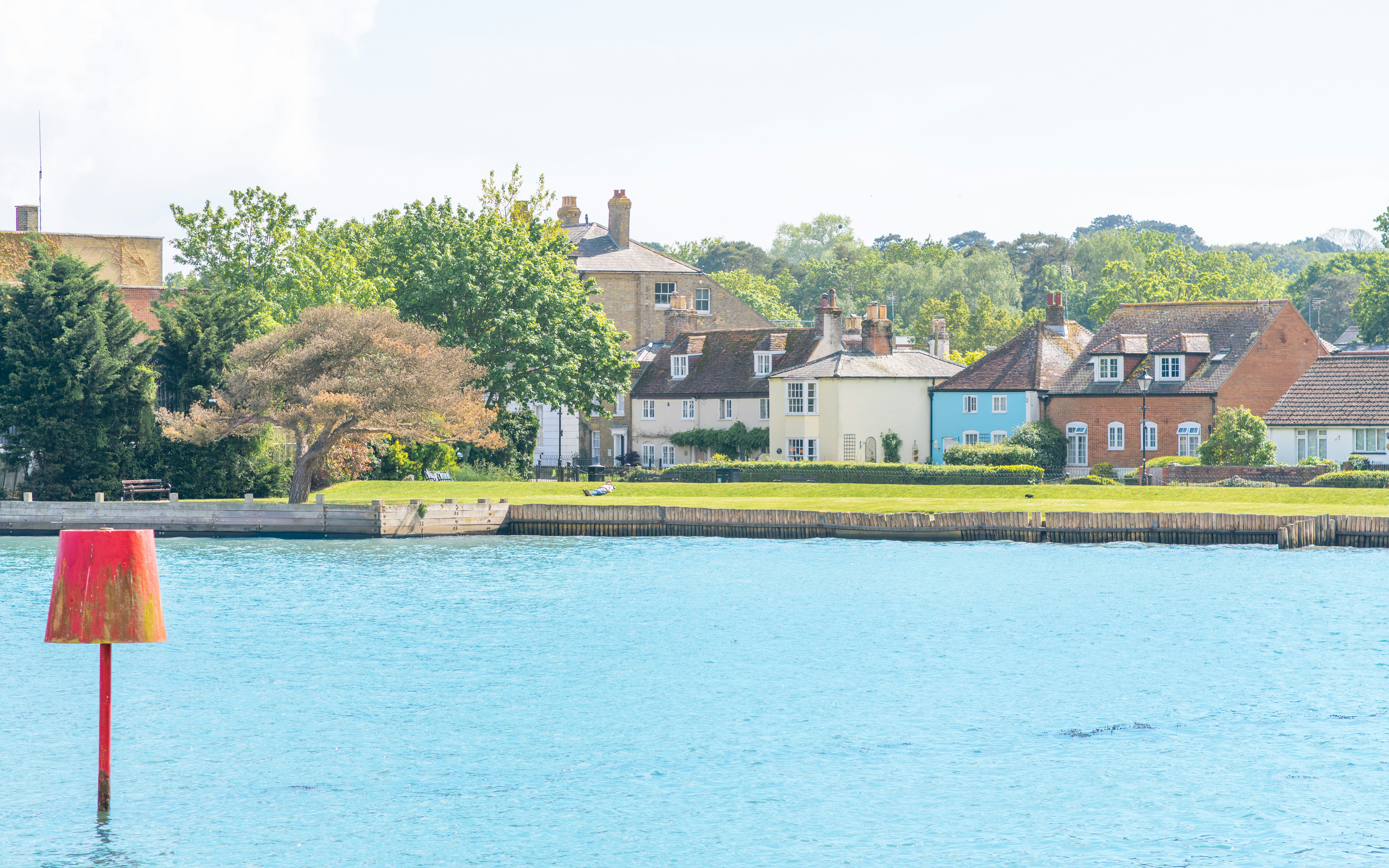 Quaint Riverside Village Across Calm Waters
