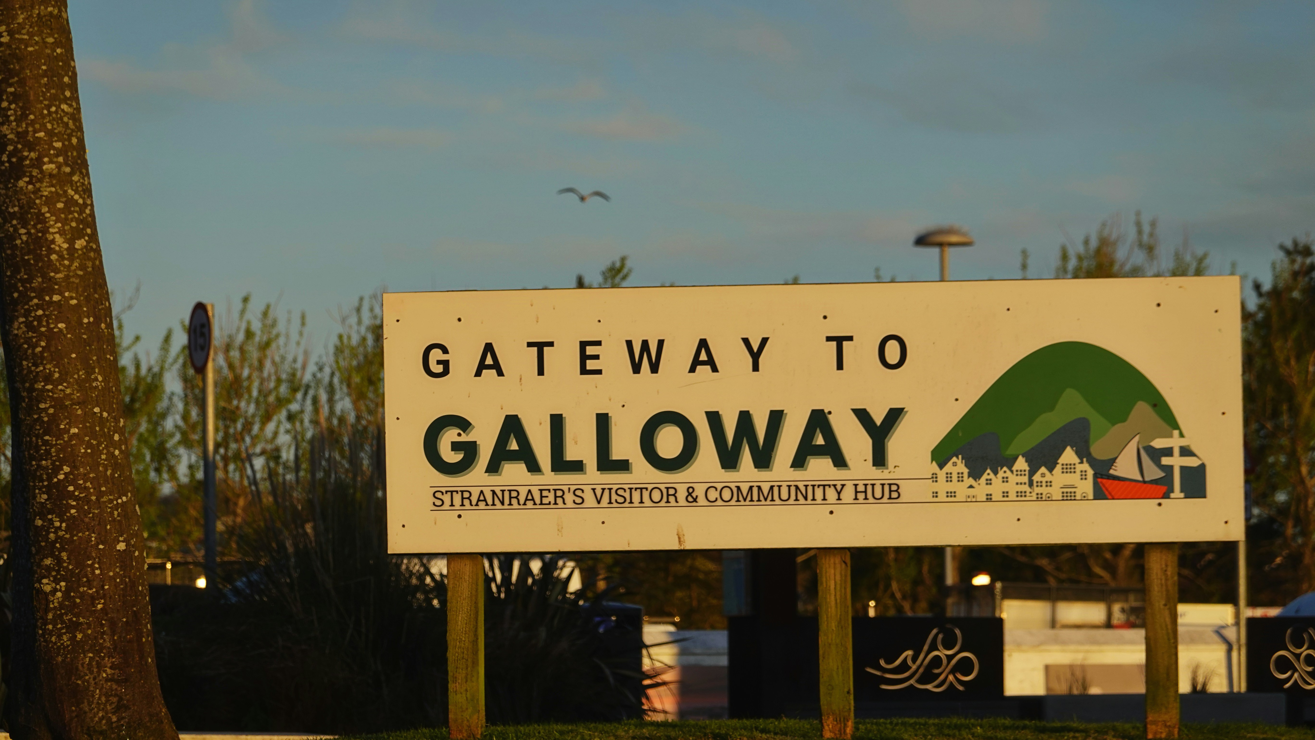 Gateway Sign to Gallowa: A Sunny Welcome at the Harbor Edge
