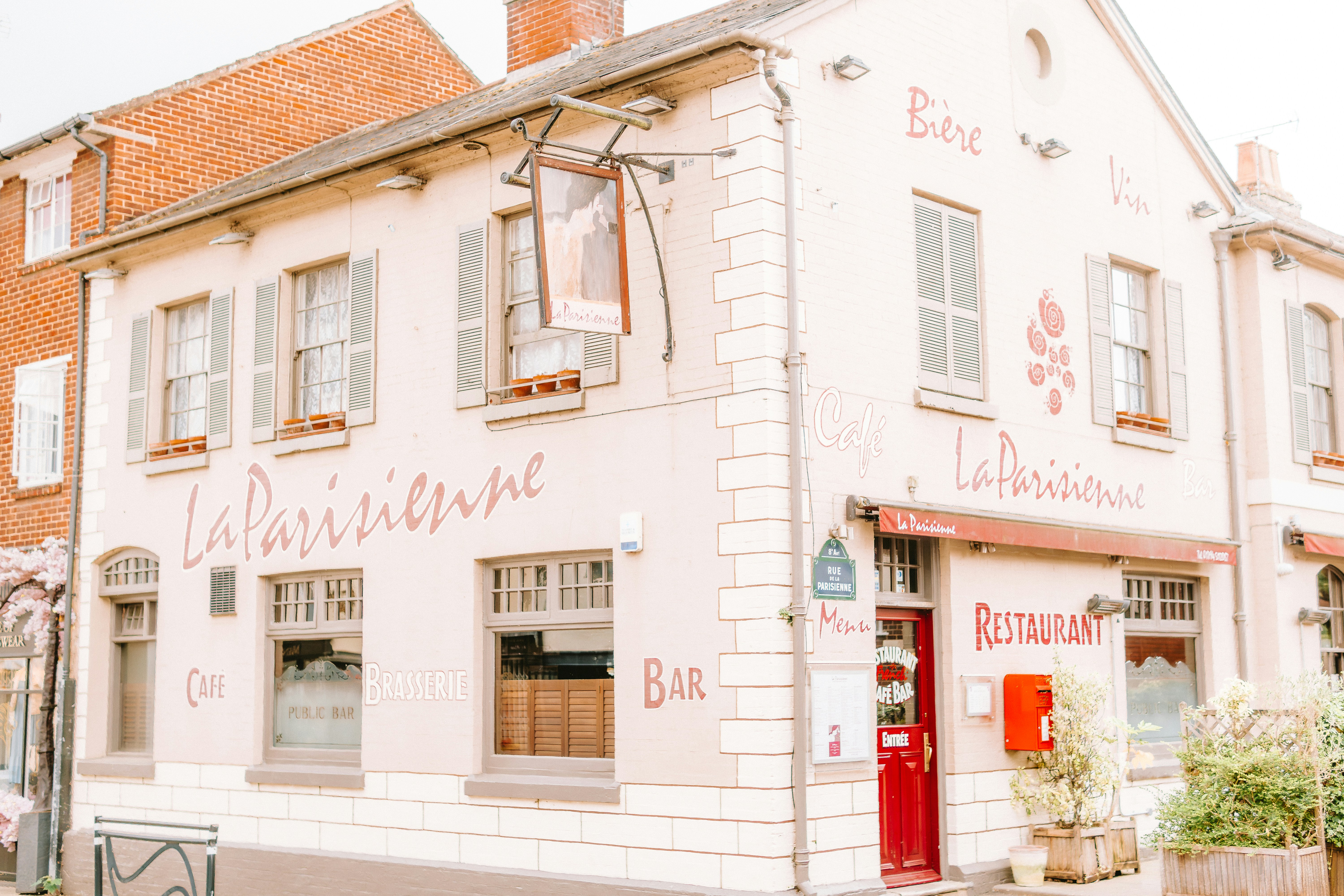 French Café Facade: Soft Sunset Hues on La Parisienne