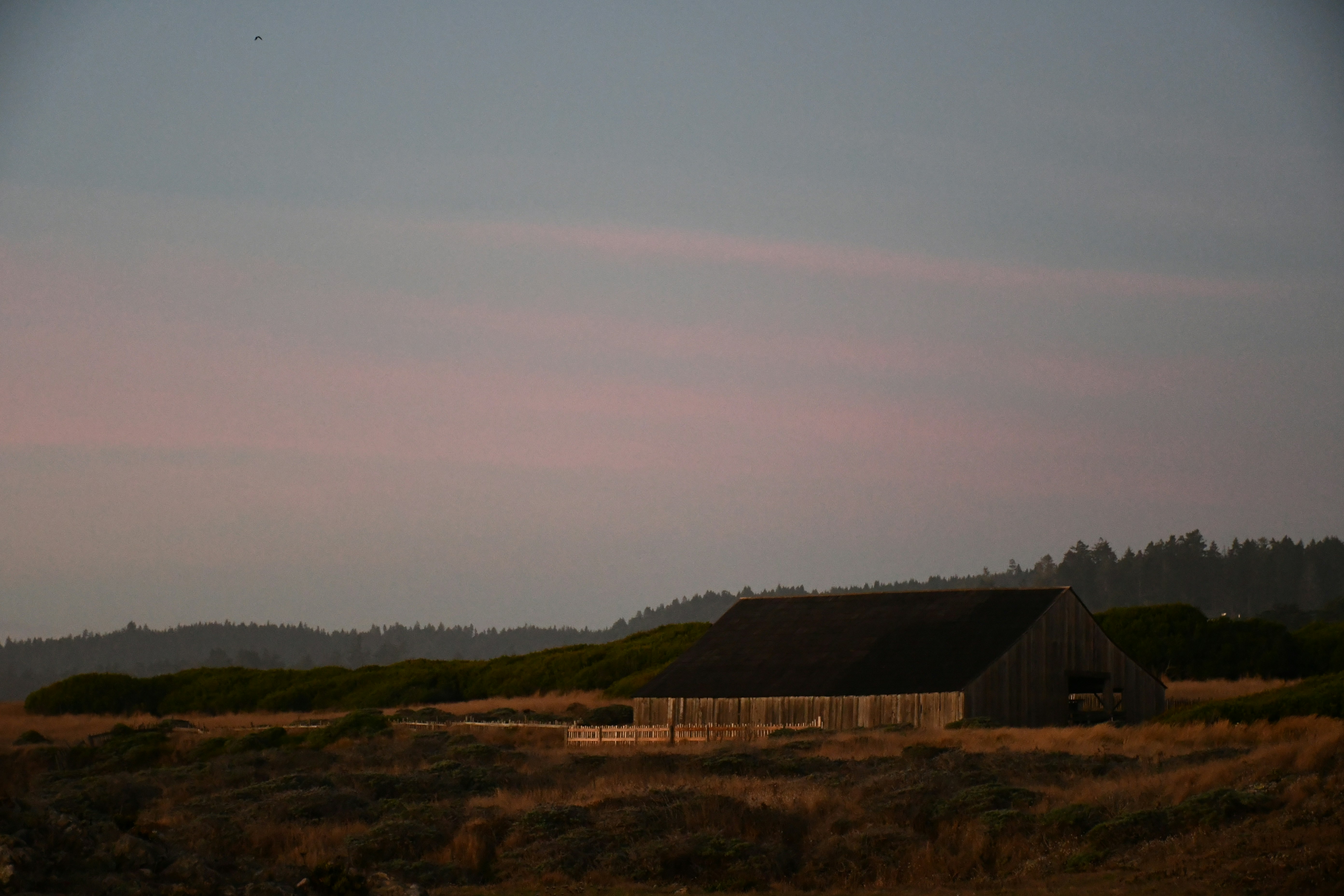 Sunset Silhouette Over an Old Barn